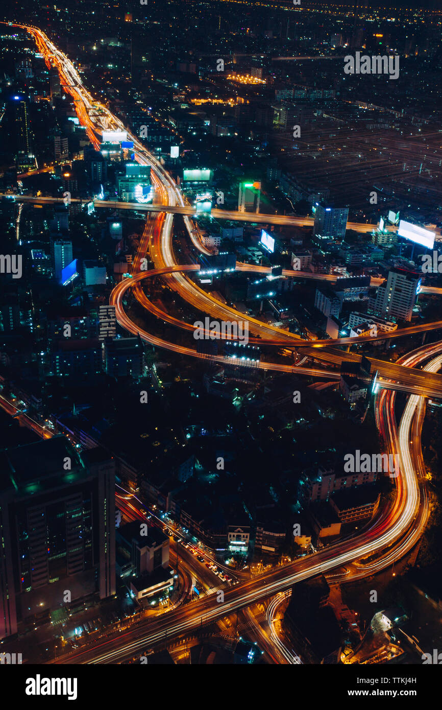 Aerial view of light trails on road amidst city at night Stock Photo ...