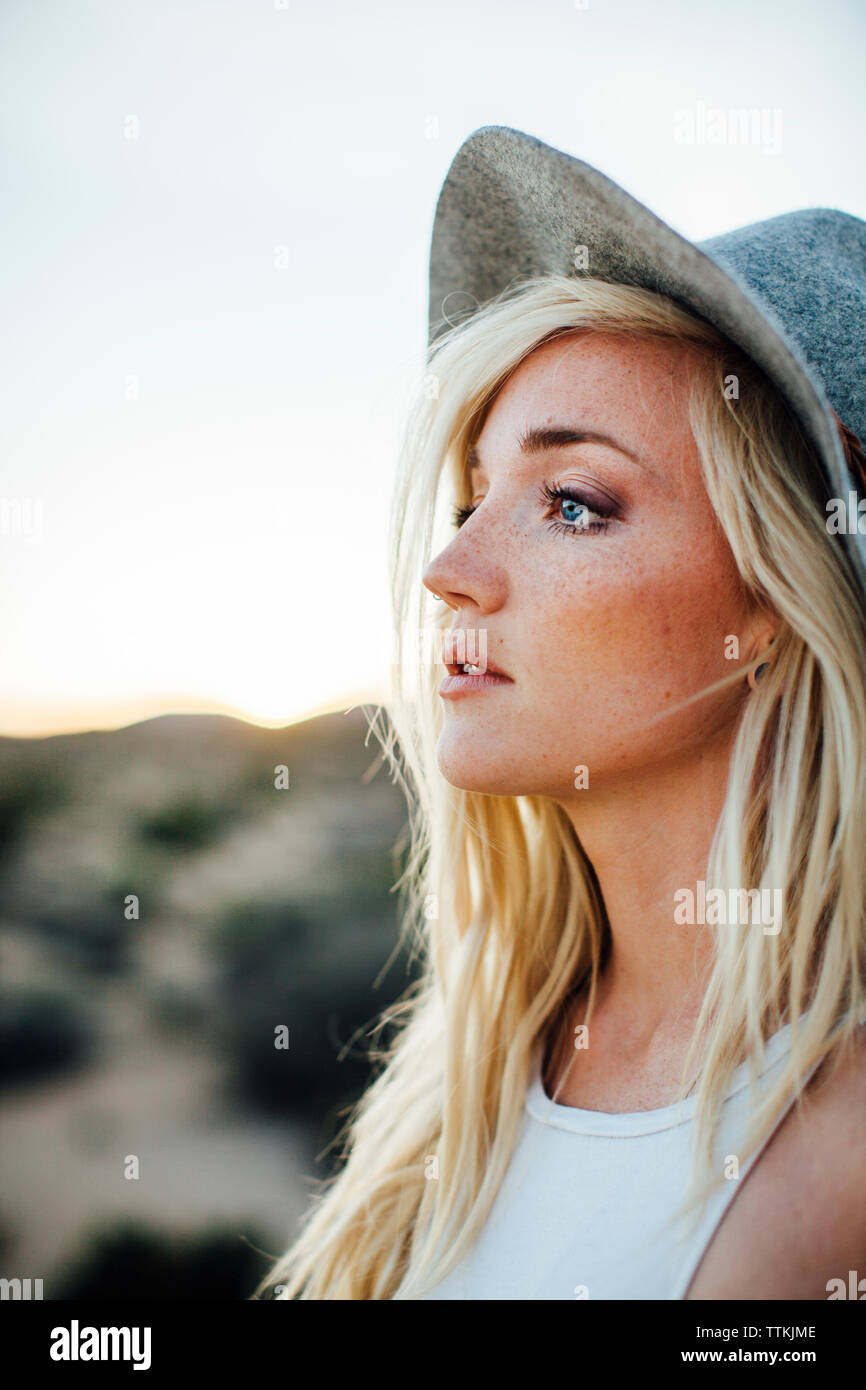 Thoughtful woman at Joshua Tree National Park against sky Stock Photo ...