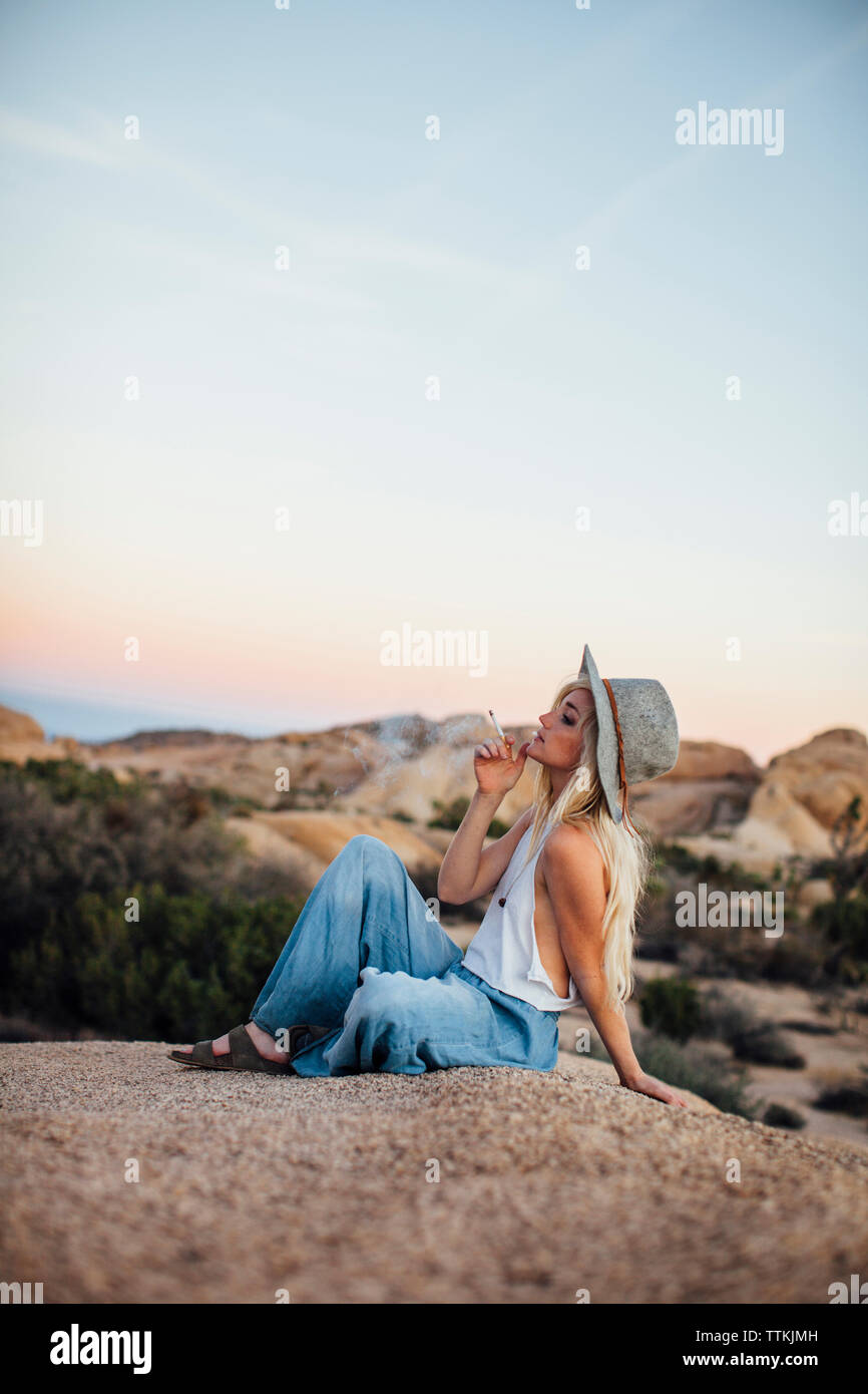 Against tree smoking cigarette hi-res stock photography and images - Alamy