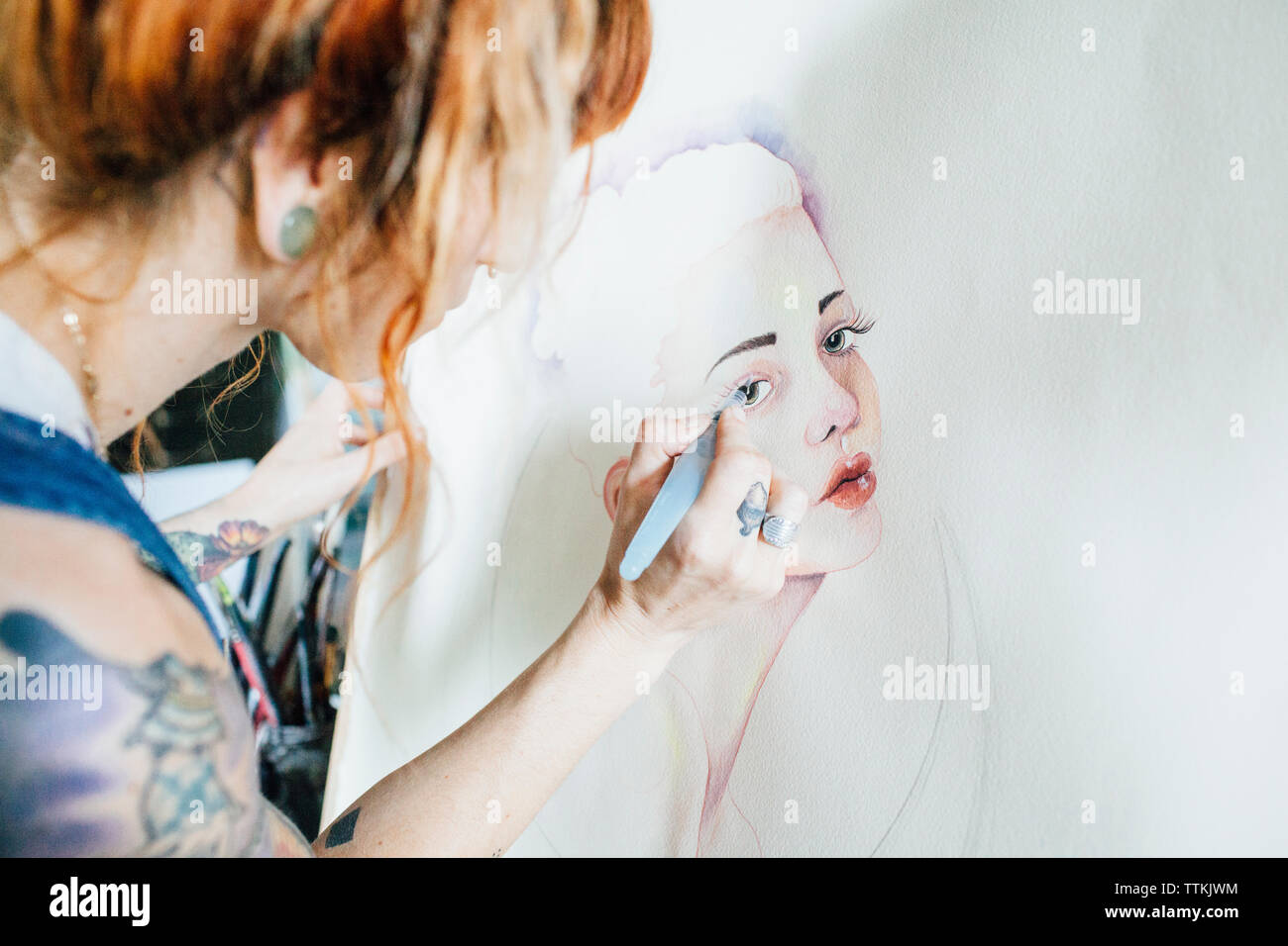 Side view of artist drawing sketch on canvas in studio Stock Photo - Alamy