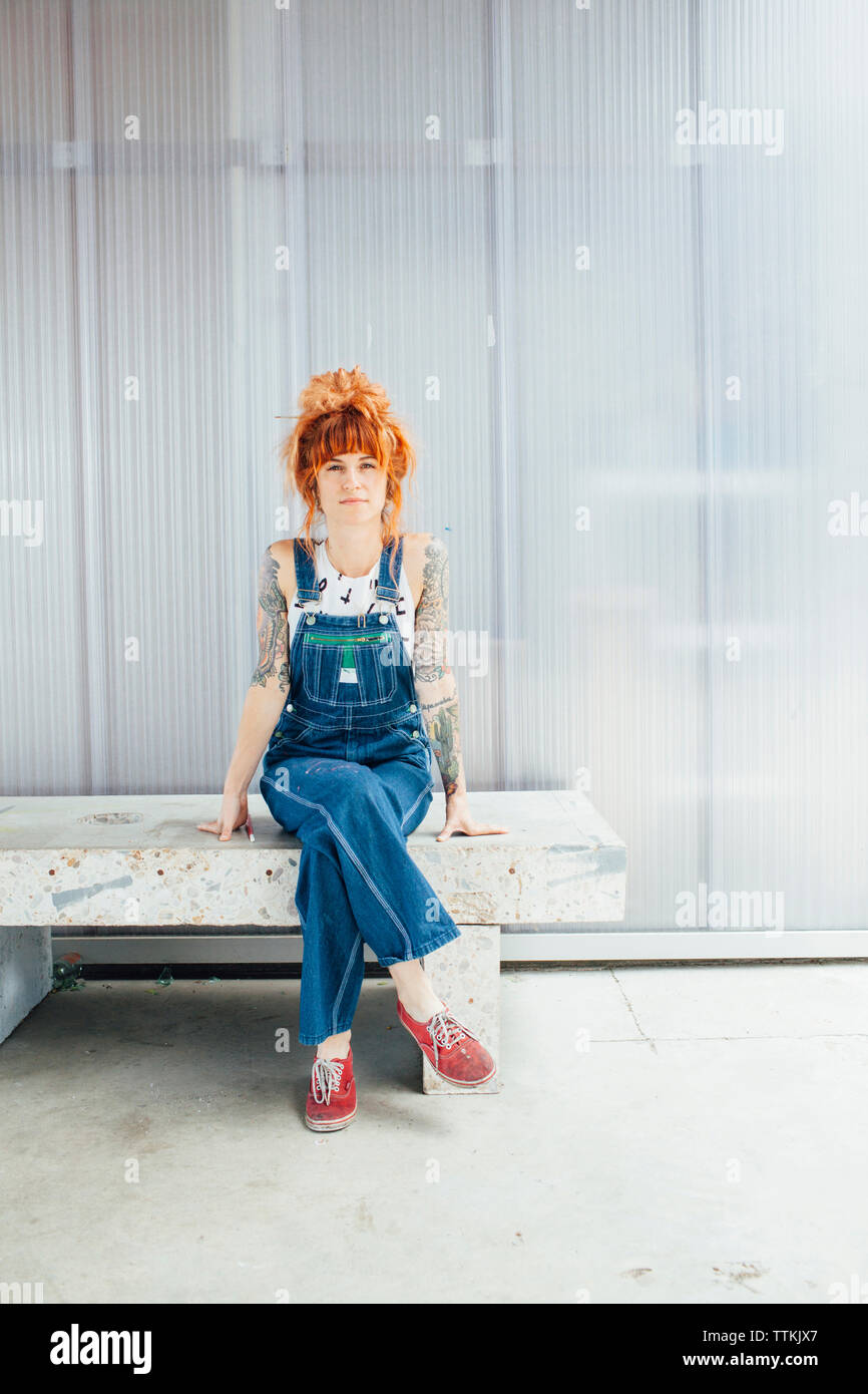 Portrait of artist sitting on seat in studio Stock Photo - Alamy