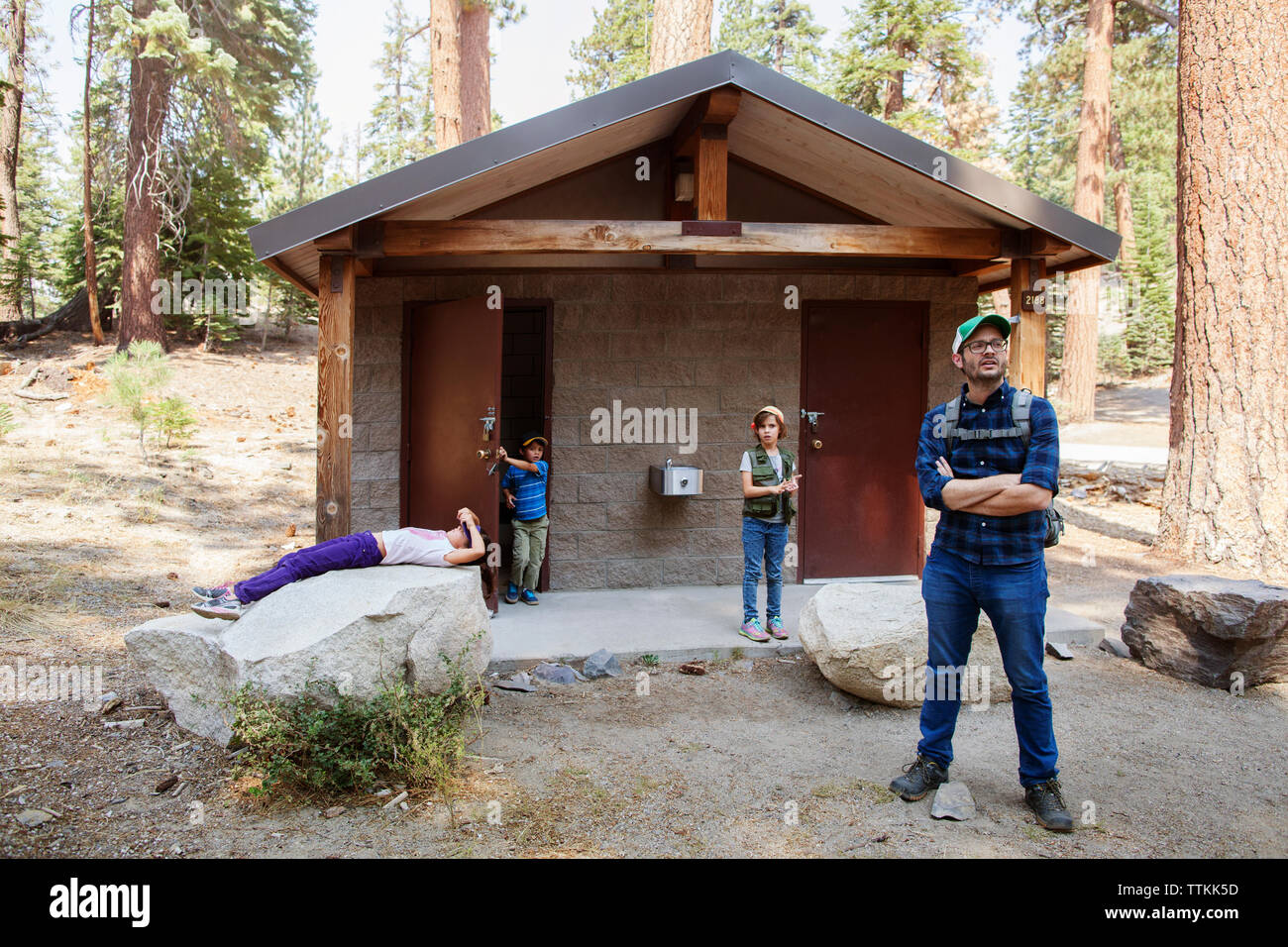 Family outside house in forest Stock Photo - Alamy
