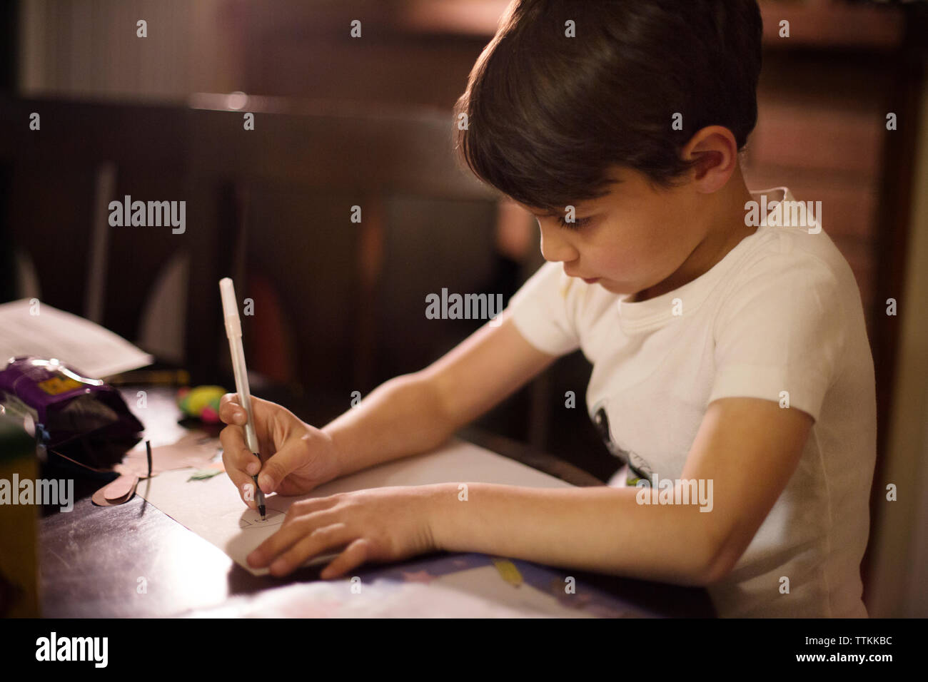 Boy drawing on paper at home Stock Photo - Alamy