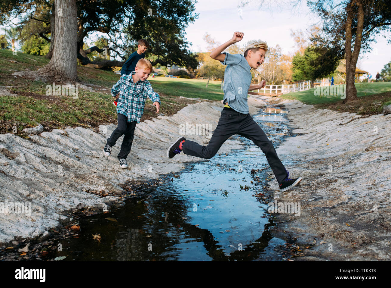 Three boys jumping water hi-res stock photography and images - Alamy