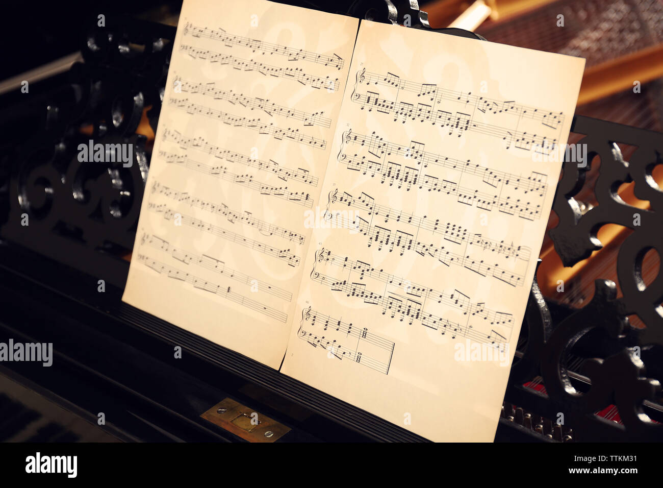 Musical notes on black piano, close up Stock Photo - Alamy