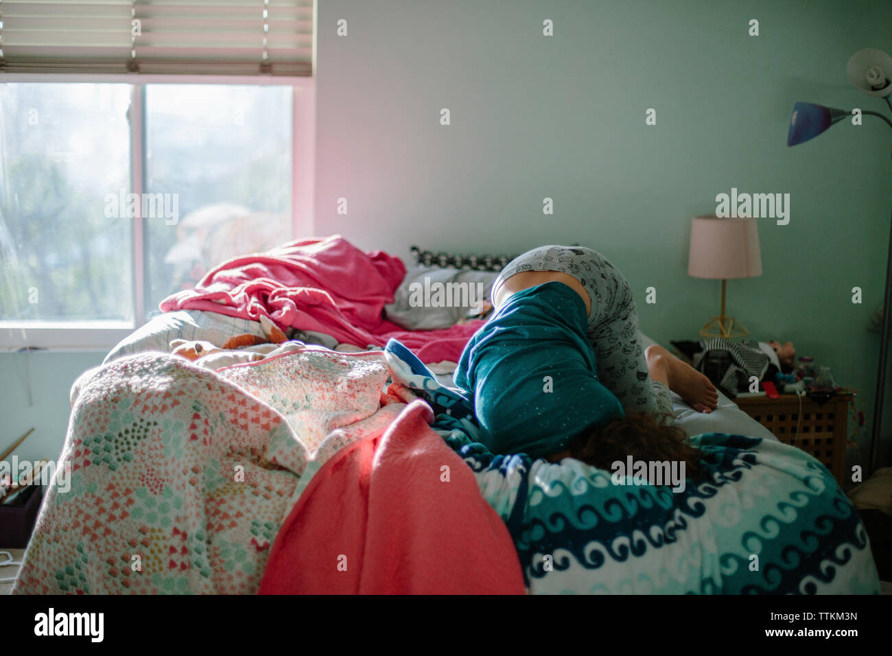 Bored girl lying on bed at home Stock Photo - Alamy