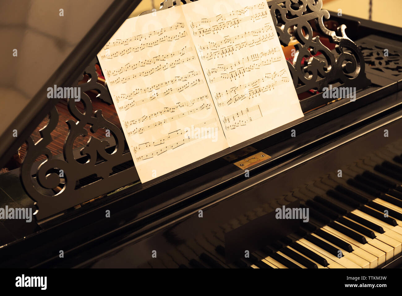 Musical notes on black piano, close up Stock Photo - Alamy