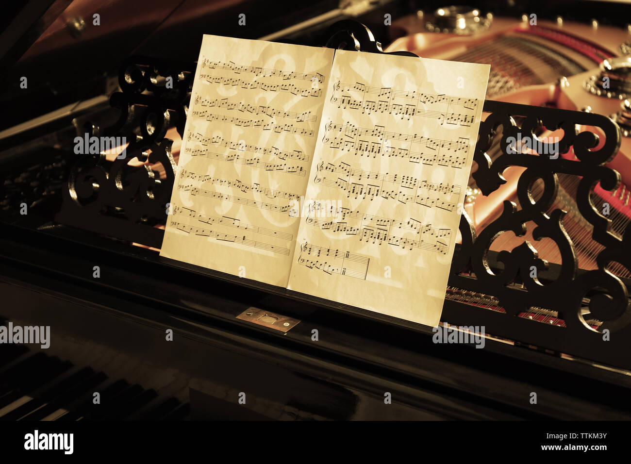 Musical notes on black piano, close up Stock Photo - Alamy