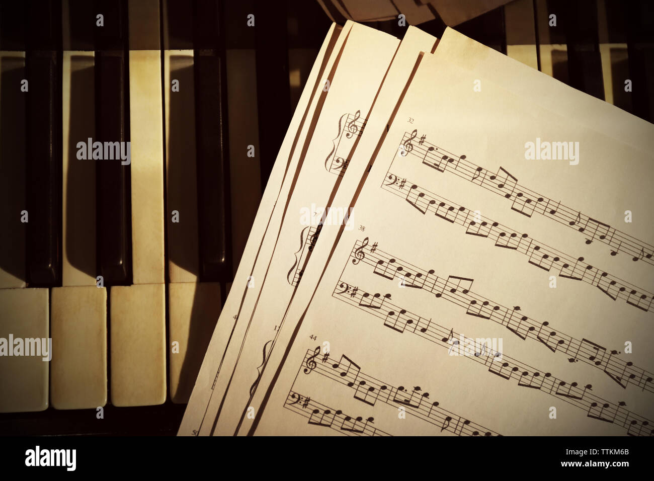 Musical notes on piano keyboard, close up Stock Photo - Alamy