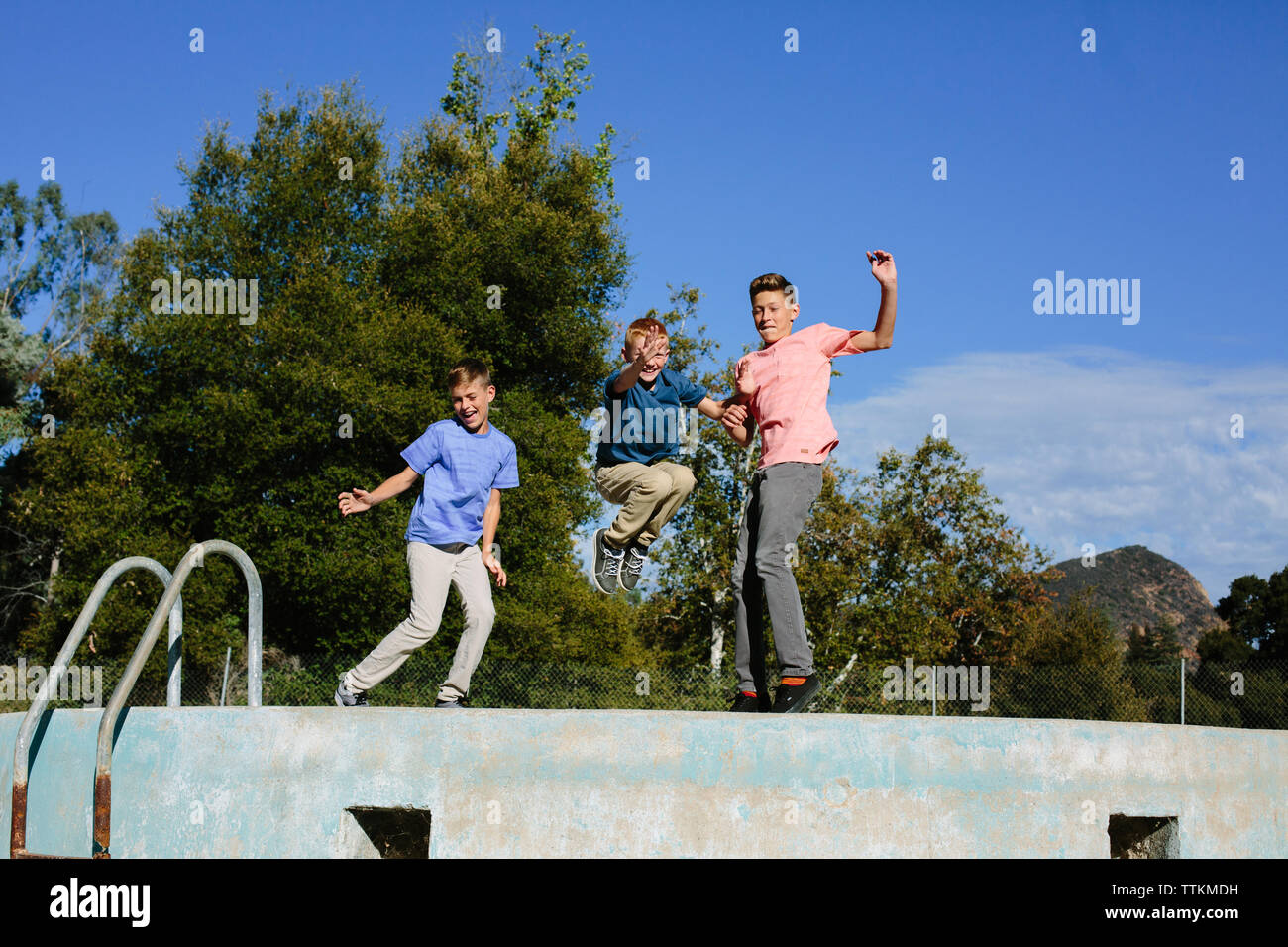 Brothers jump in the air in the direct sunlight Stock Photo - Alamy