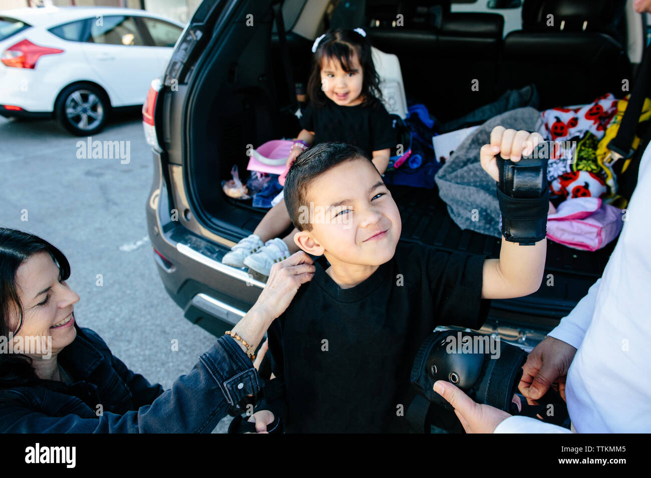 Little boy shows off his wrist guard as parents dress him Stock Photo ...