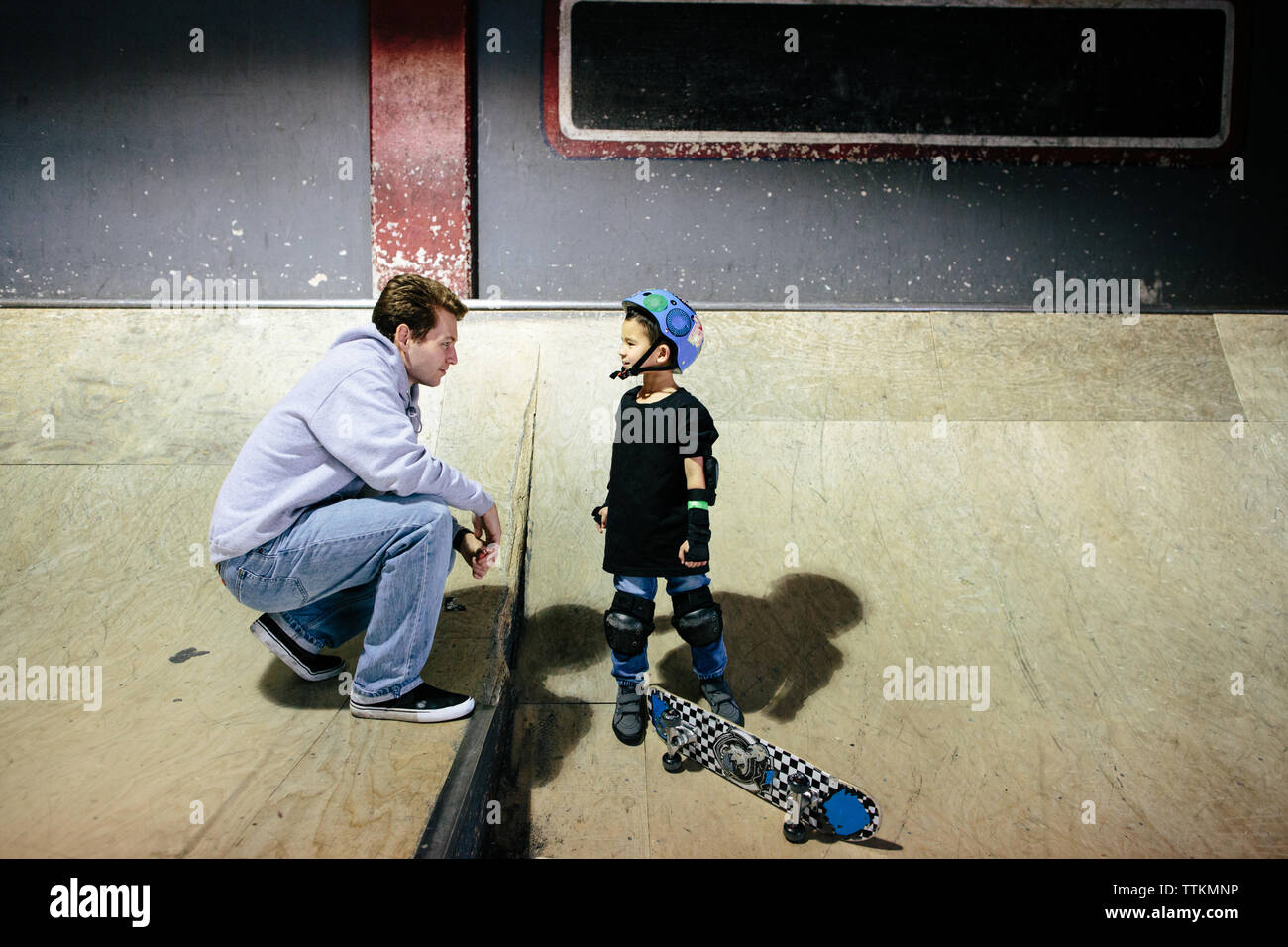 Skateboarding instructor and student stand on ramp and talk Stock Photo ...