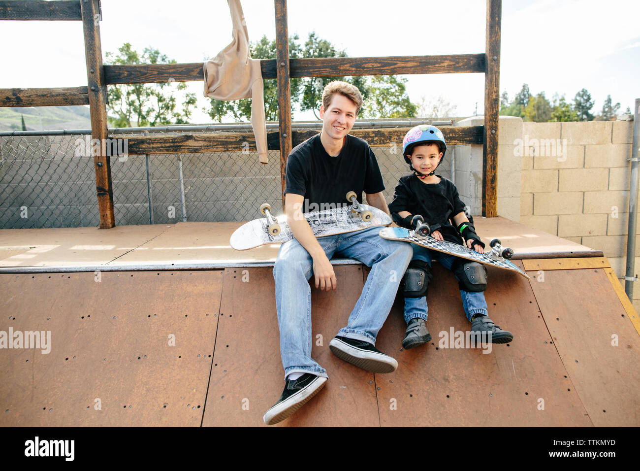 Skateboard instructor and student smile for a portrait Stock Photo - Alamy