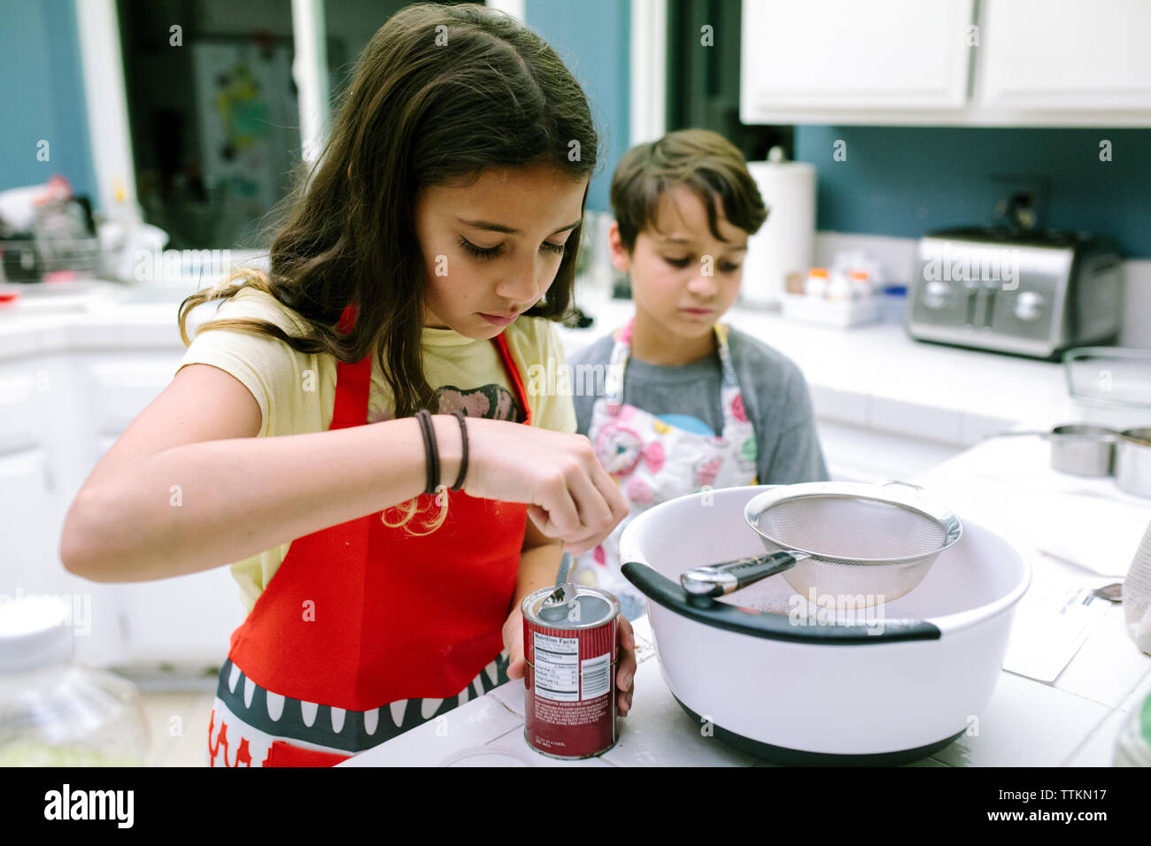 Girl measures baking powder while baking Stock Photo - Alamy