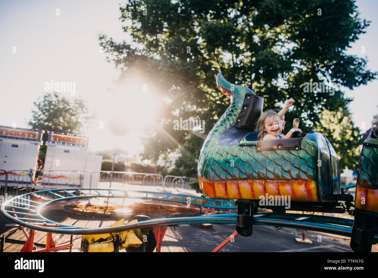 Happy sisters enjoying in amusement park ride Stock Photo - Alamy