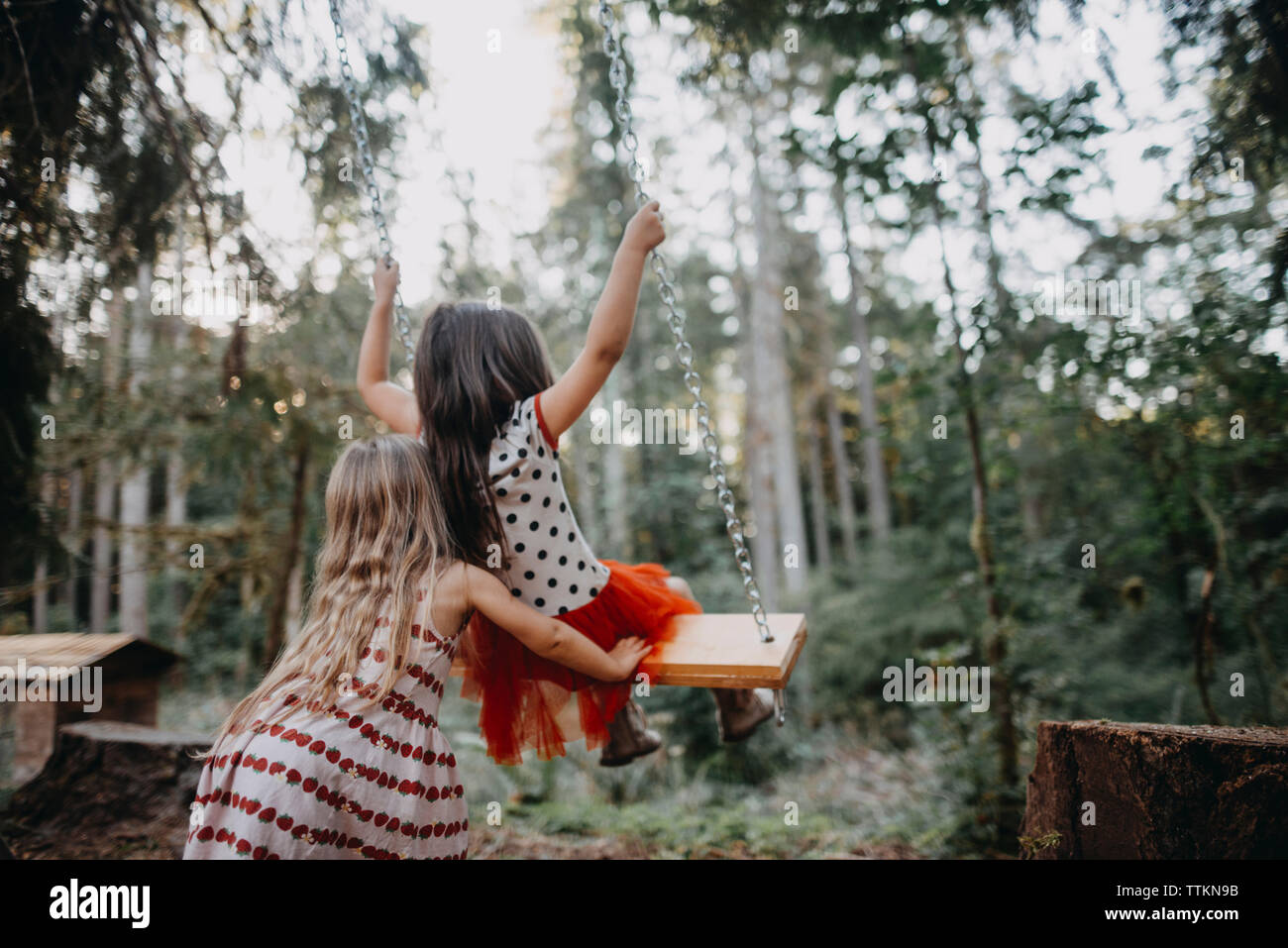 Pushing swing hi-res stock photography and images - Alamy