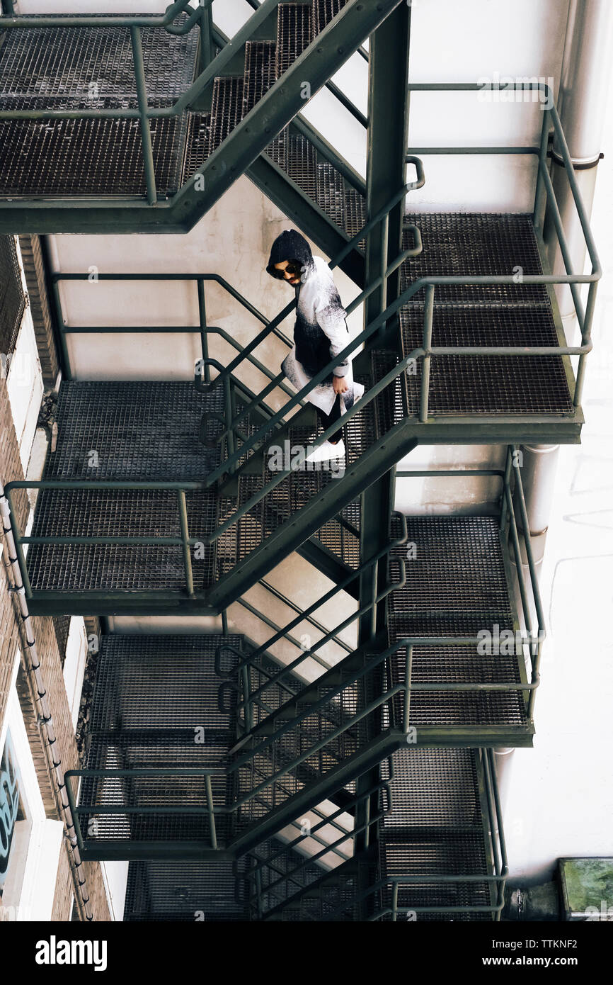 High angle view of man moving down on fire escape Stock Photo - Alamy