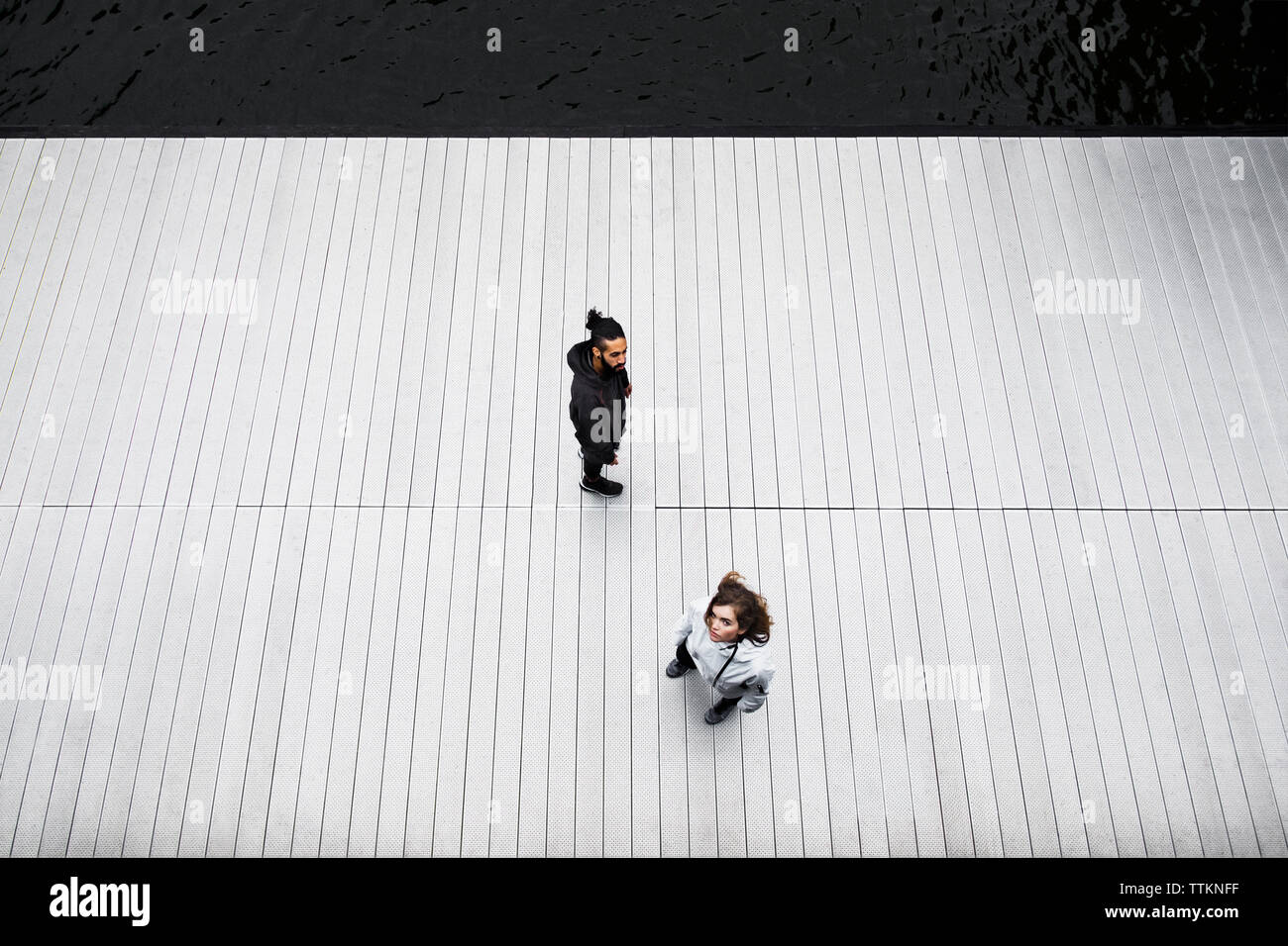 Woman standing on pavement hi-res stock photography and images - Alamy