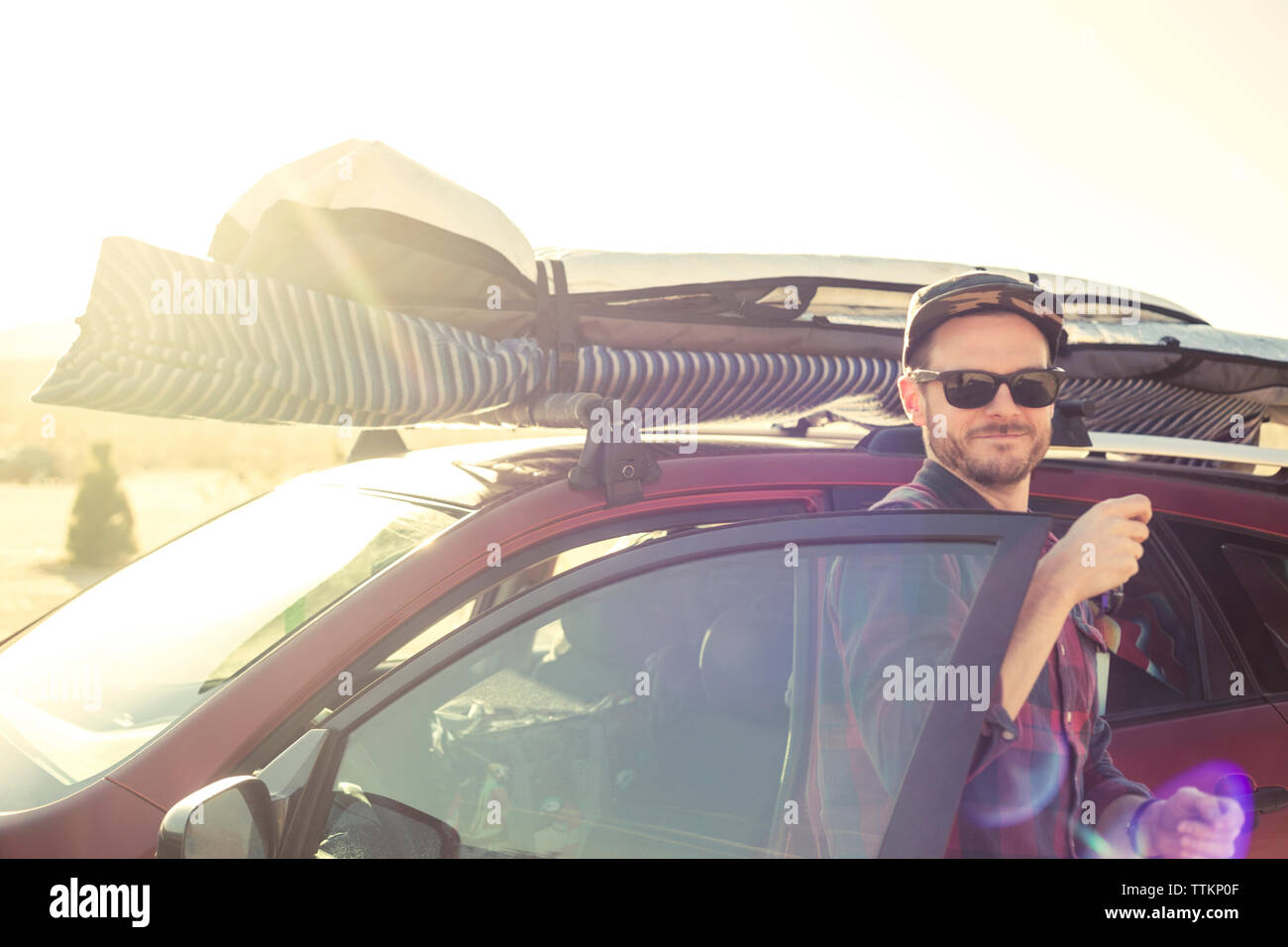 Man standing on the roof of the car hi-res stock photography and images ...
