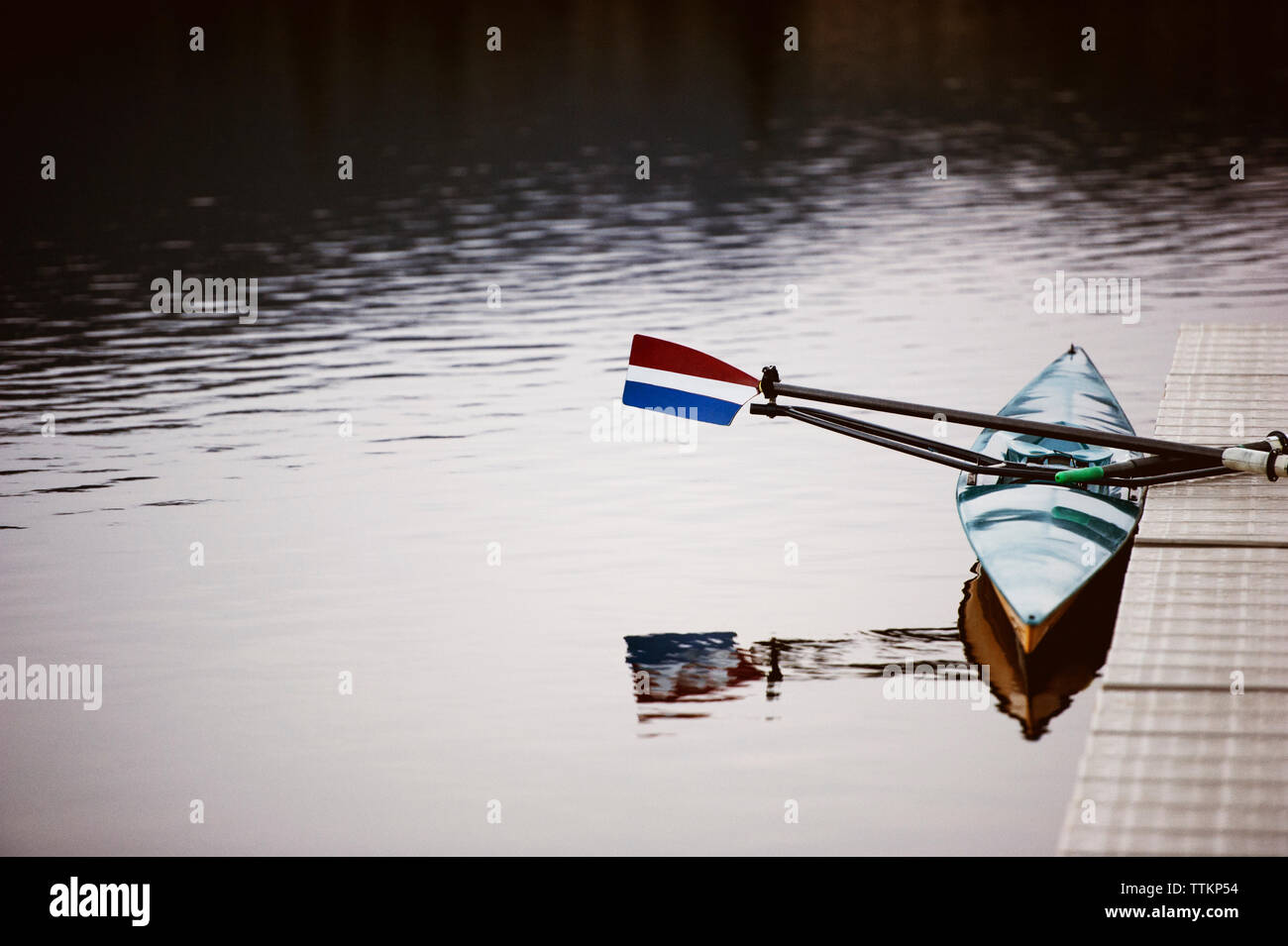 Kayak with oars moored on lake Stock Photo - Alamy