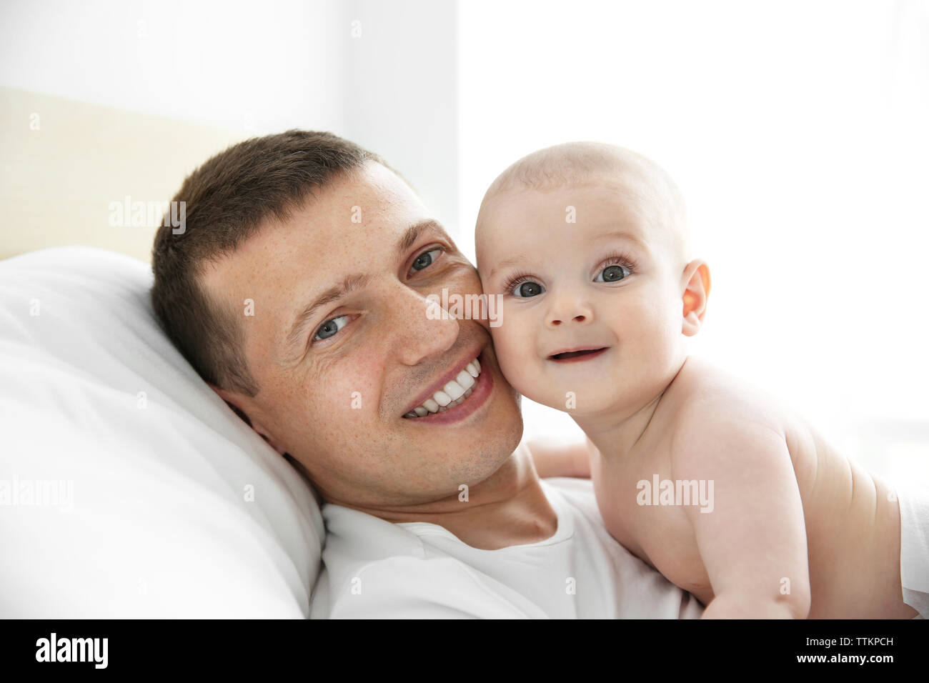 Portrait of happy father and cute baby Stock Photo - Alamy