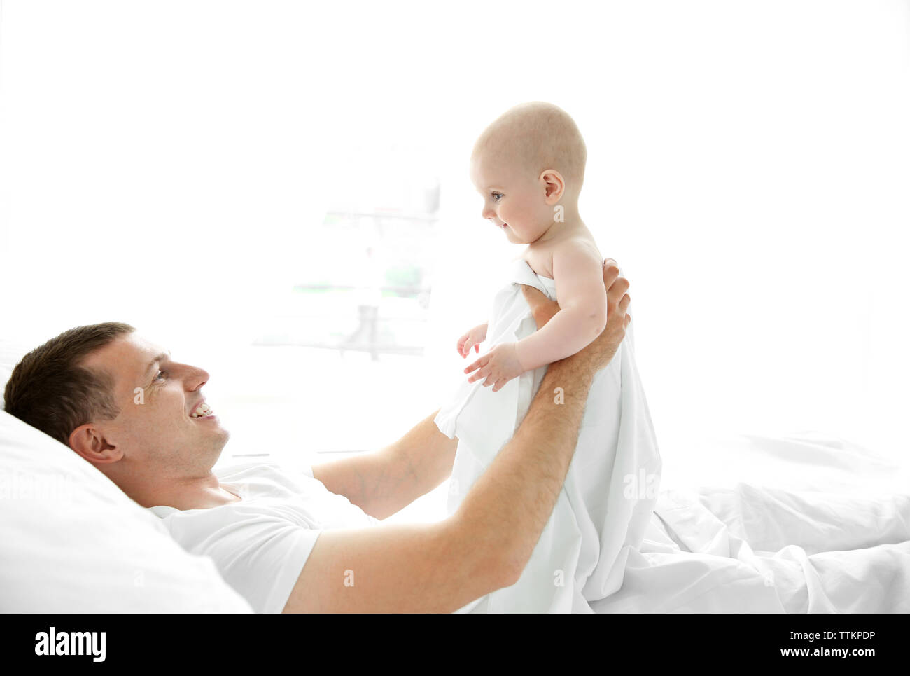 Father playing with smiling baby Stock Photo - Alamy