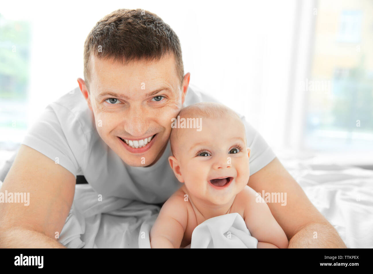 Portrait of happy father and cute baby Stock Photo - Alamy