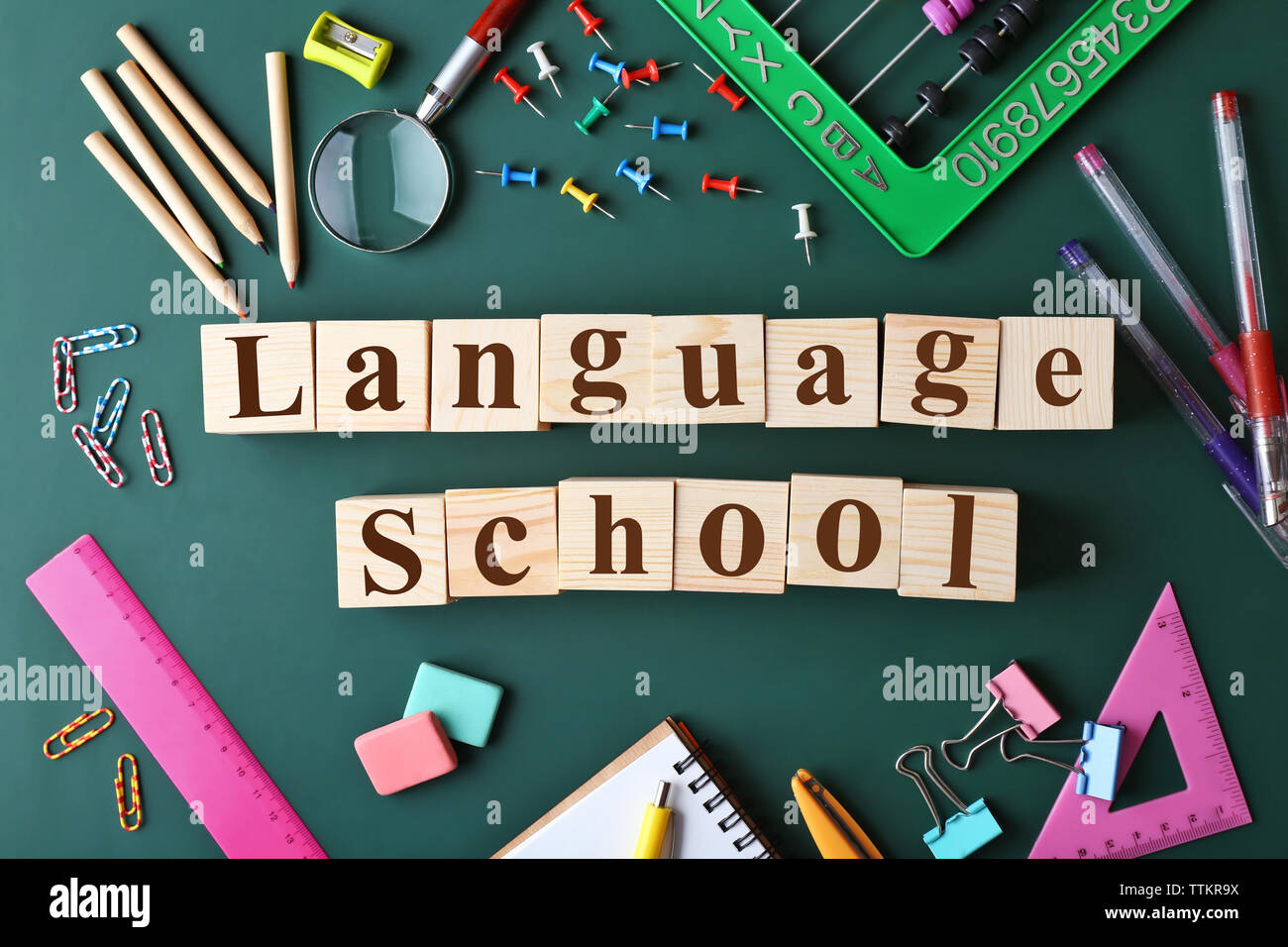 Colourful stationery and words LANGUAGE SCHOOL on chalkboard Stock ...