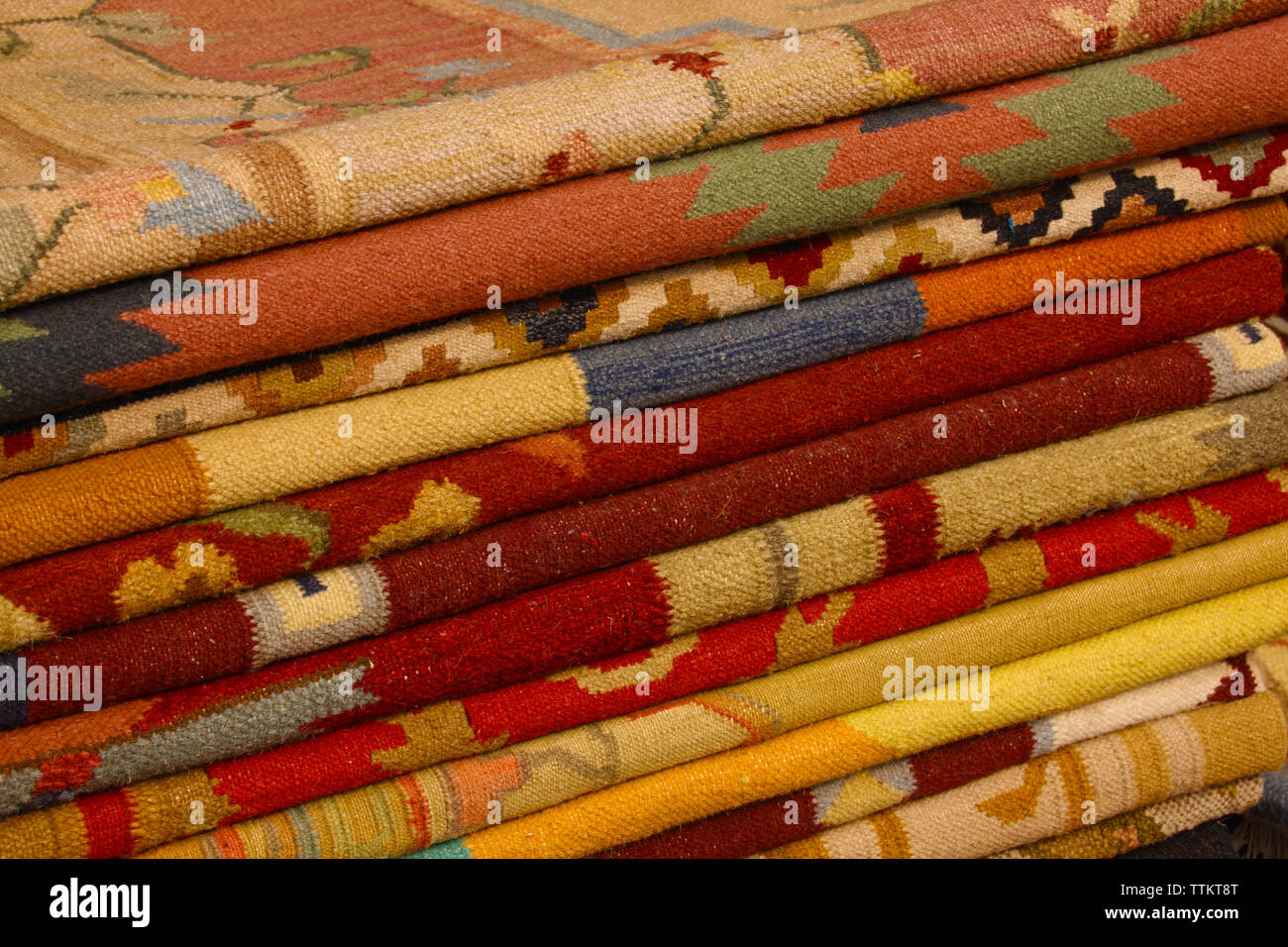 Stack of rugs at a market stall, Dilli Haat, New Delhi, India Stock ...