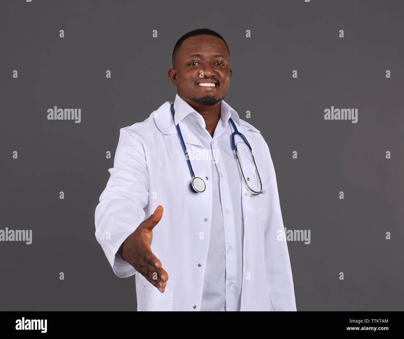 Professional African doctor on dark background Stock Photo - Alamy