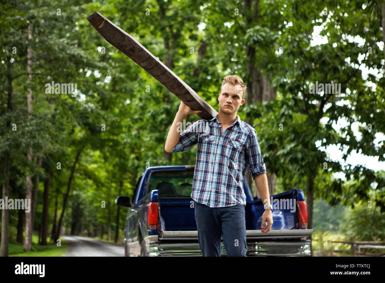 Walking man carrying wood hi-res stock photography and images - Alamy