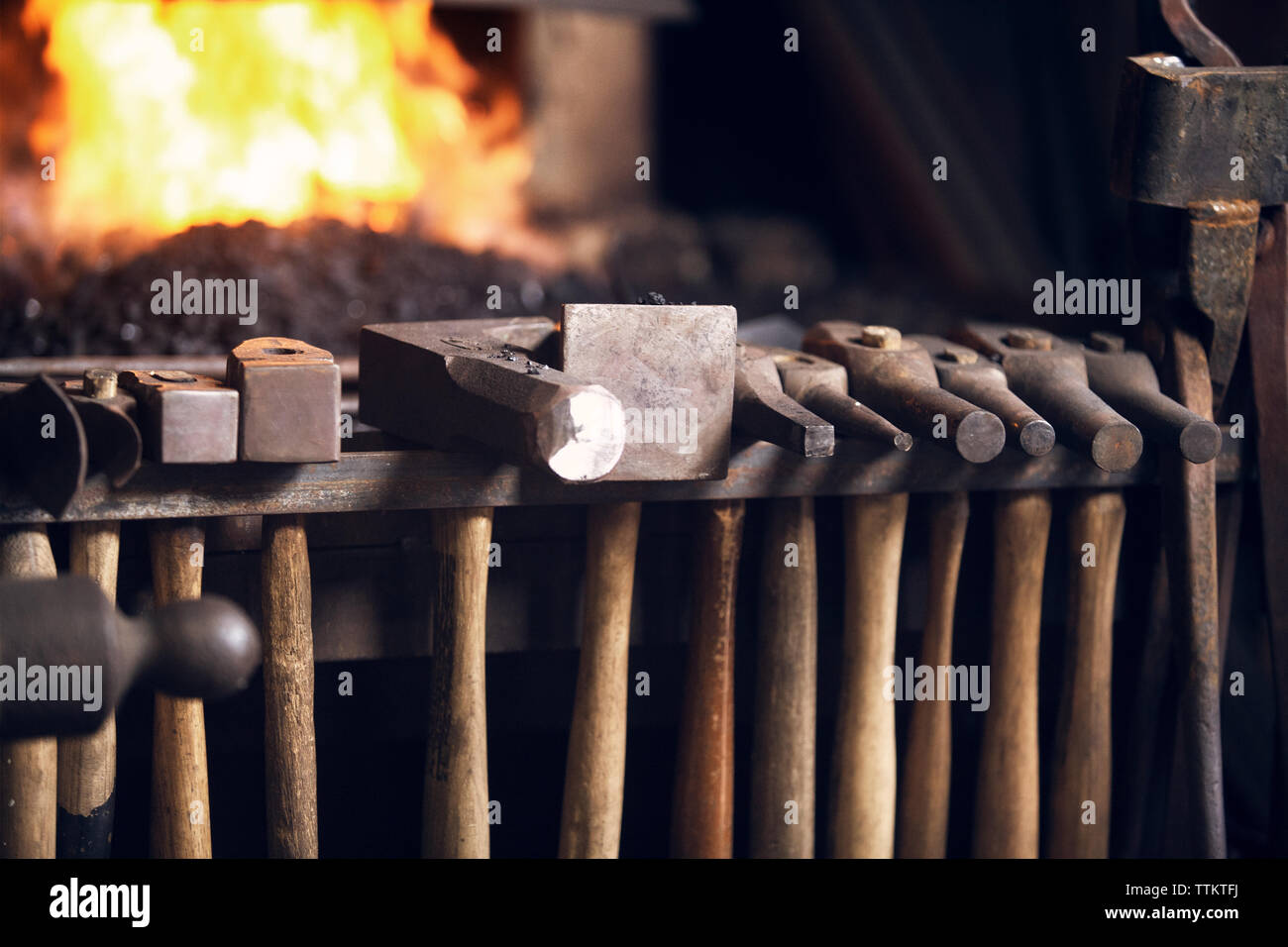 Various hammers hanging on rack in blacksmith shop Stock Photo - Alamy