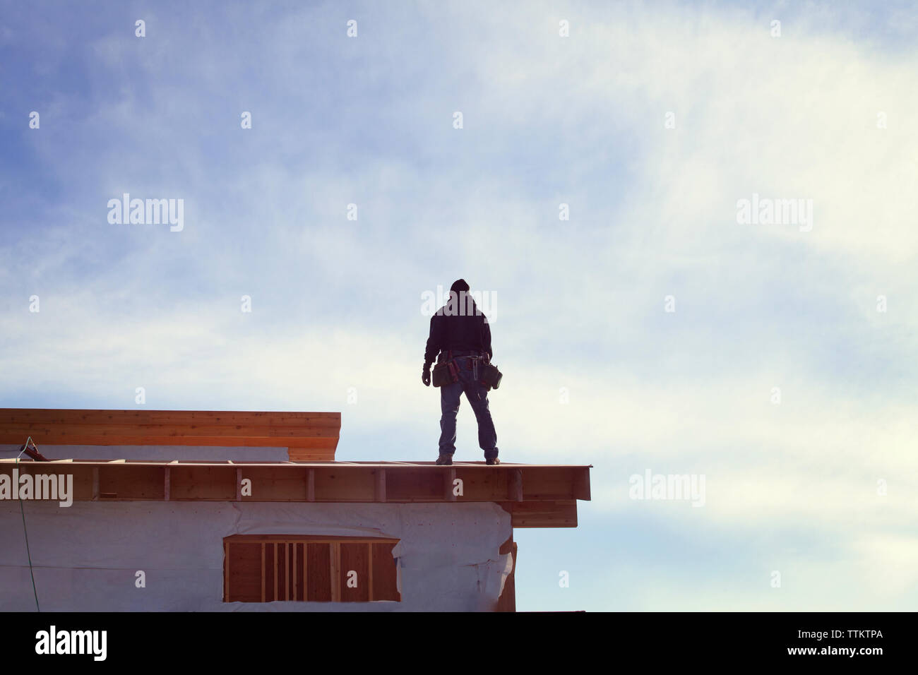 Man standing on roof beam hi-res stock photography and images - Alamy