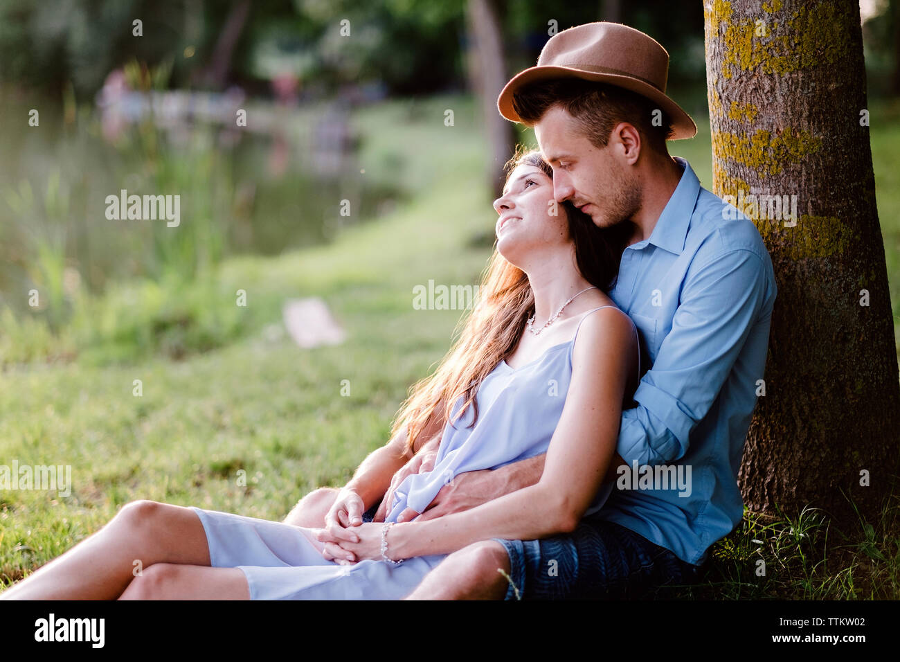 Couple tree sitting hi-res stock photography and images - Alamy
