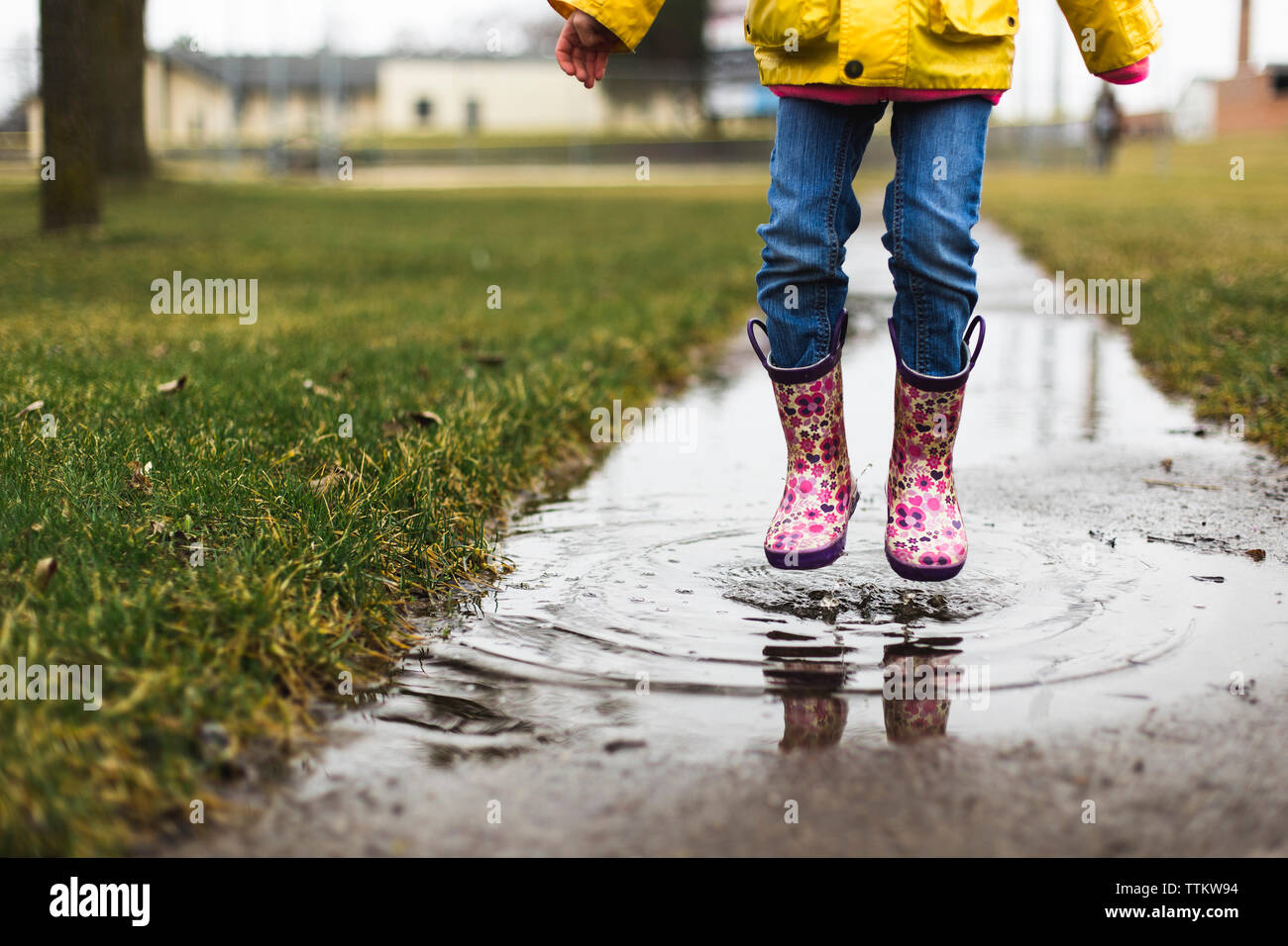 Girl jumping into puddle hi-res stock photography and images - Alamy