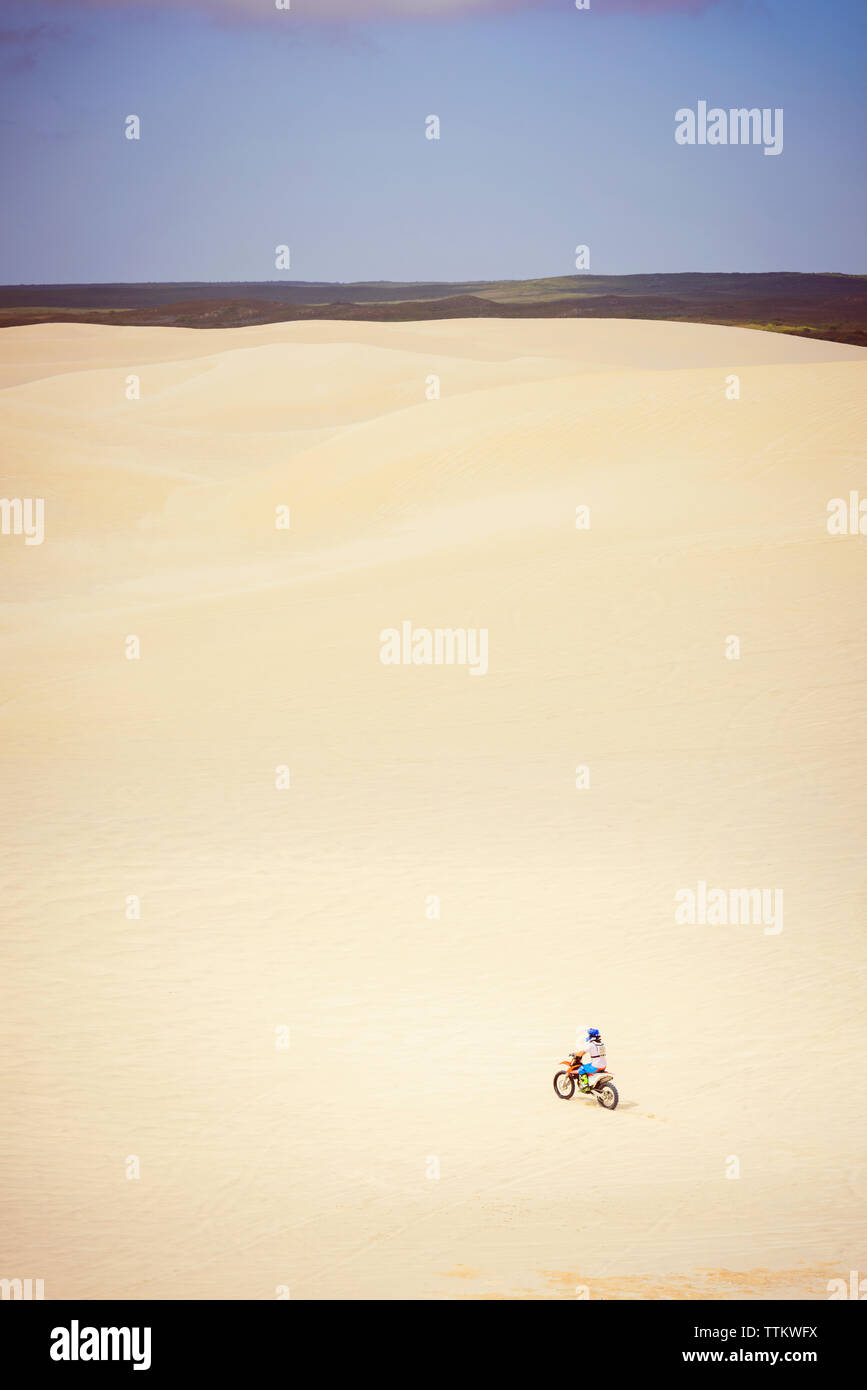 Teenage girl riding bicycle on desert Stock Photo - Alamy