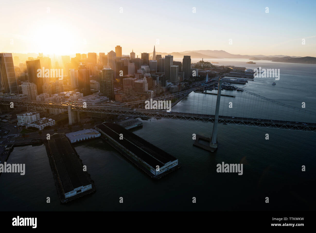 Aerial view of Bay Bridge by cityscape during sunset Stock Photo - Alamy