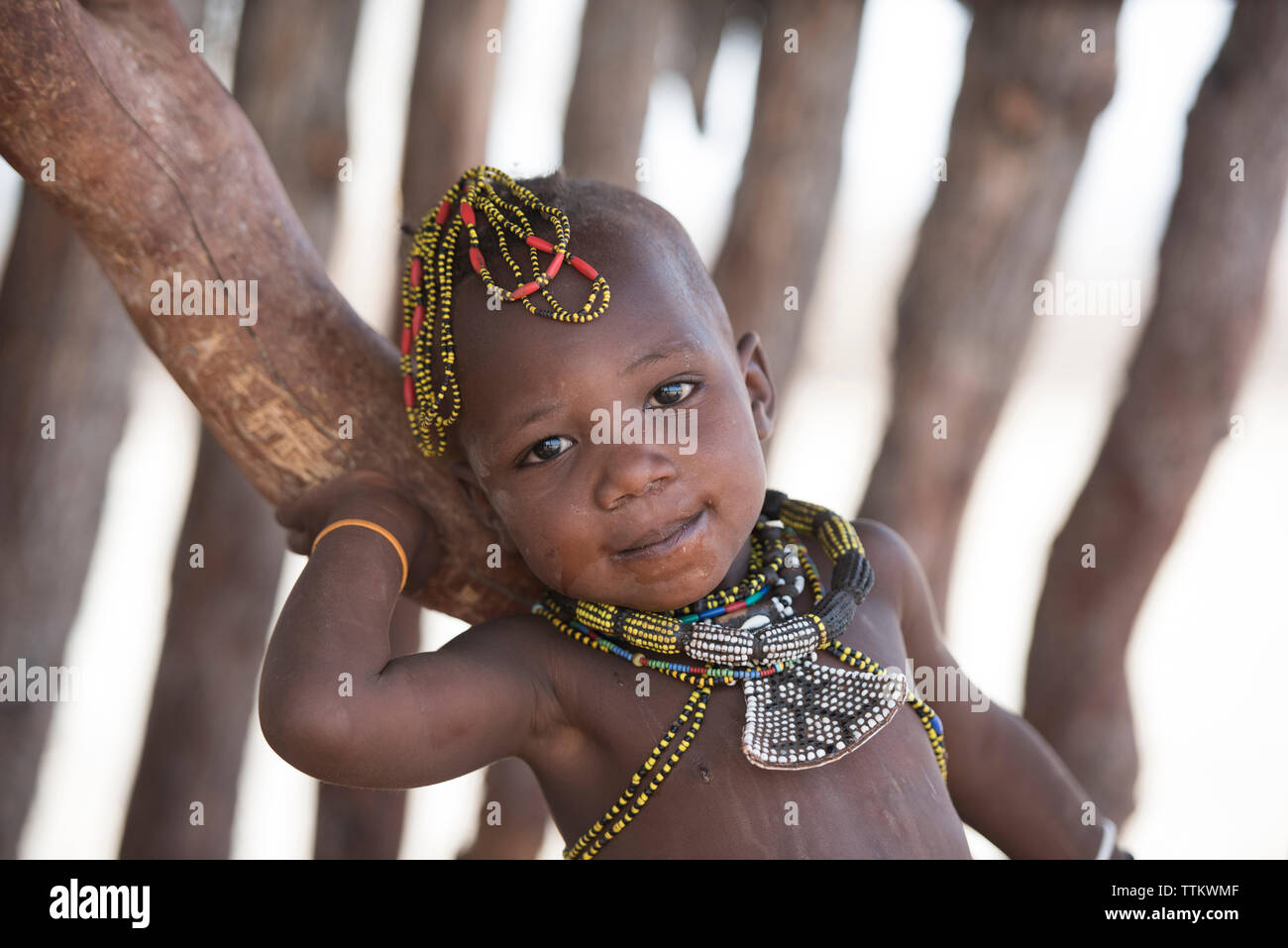 Close-up portrait of shirtless girl leaning on tree Stock Photo - Alamy