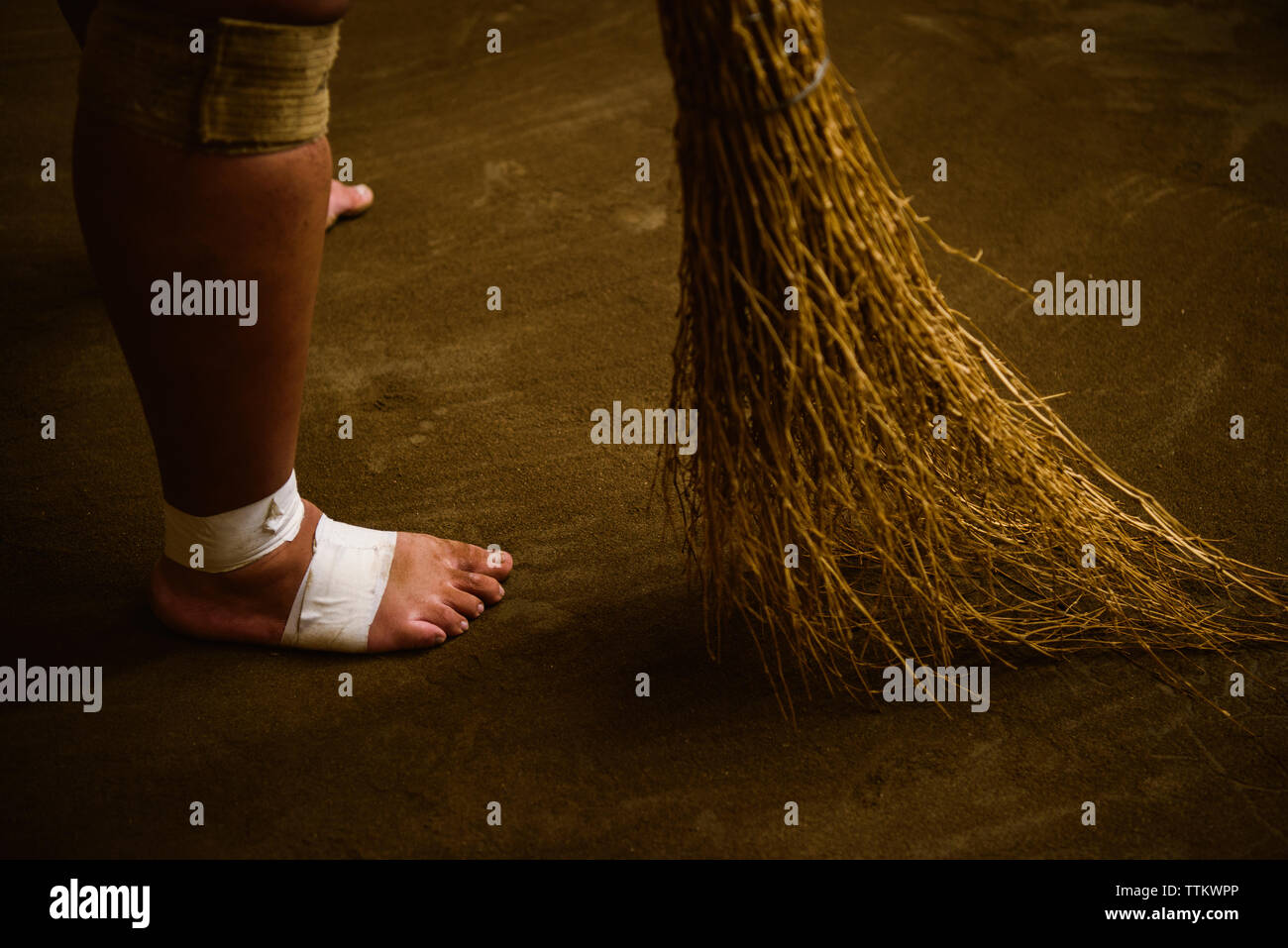 Low section of wrestler sweeping field in sumo beya Stock Photo - Alamy