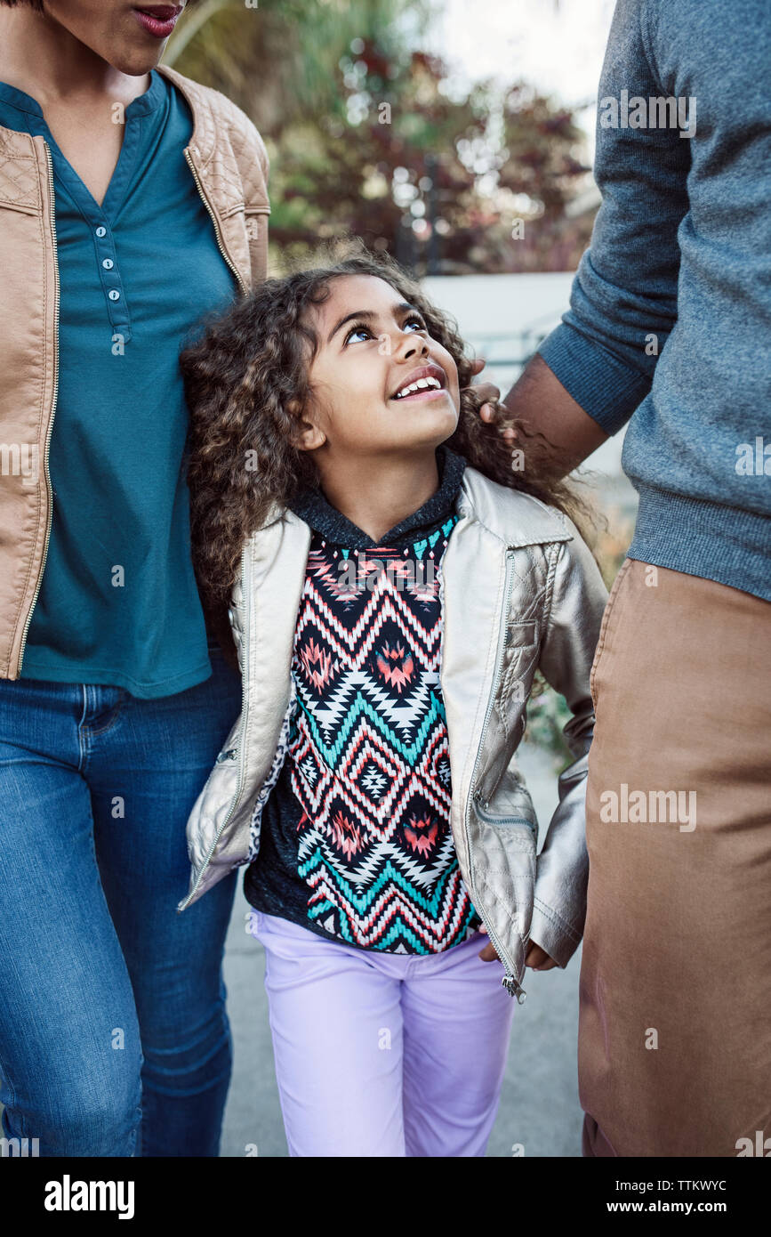Daughter walking with parents on footpath Stock Photo - Alamy