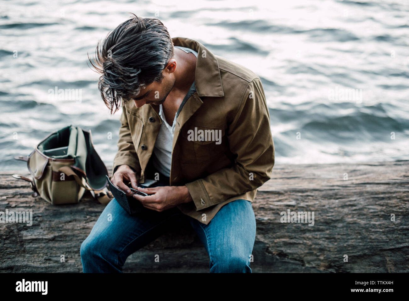 Man sitting on log on hi-res stock photography and images - Alamy