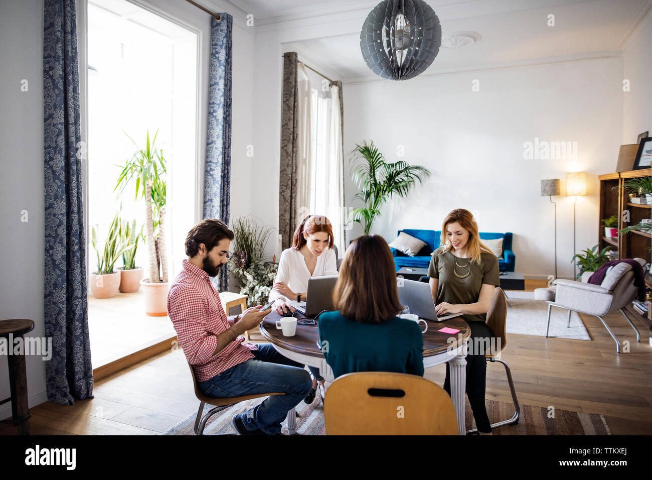 Creative people working at table in creative office Stock Photo - Alamy