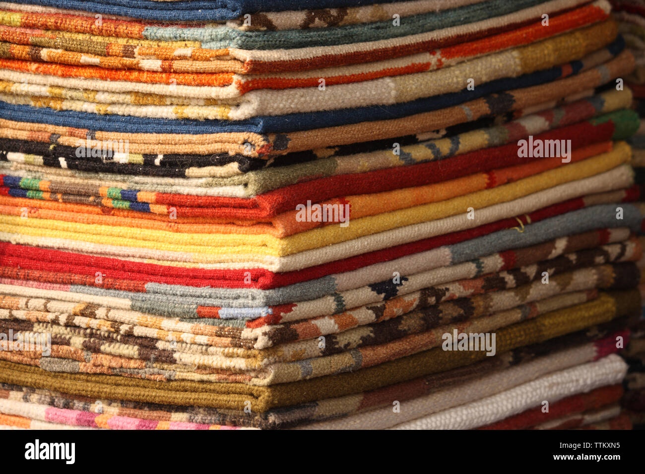 Stack of rugs at a market stall, Dilli Haat, New delhi, India Stock ...
