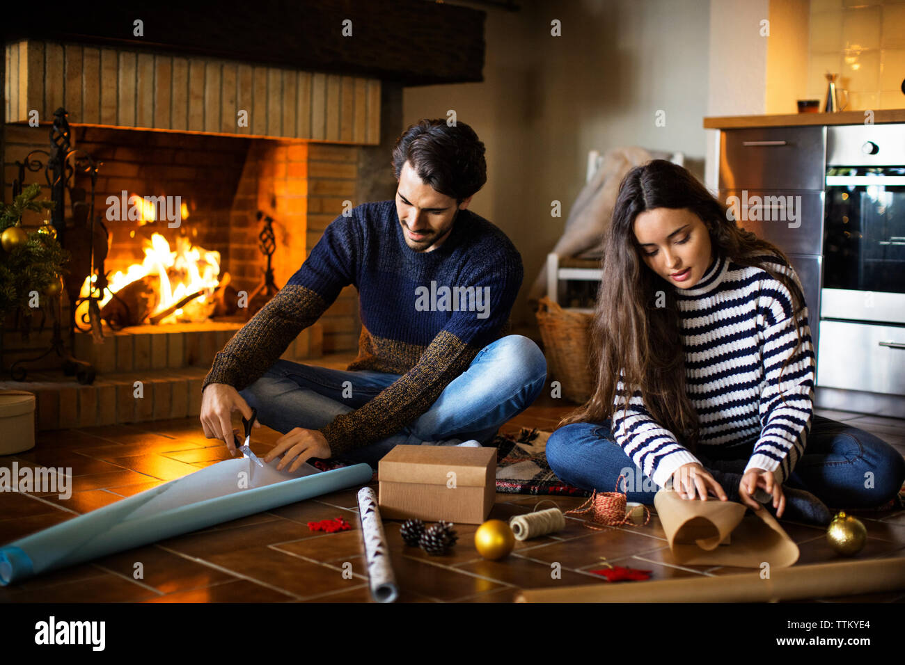 Woman sitting on floor wrapping hi-res stock photography and images - Alamy