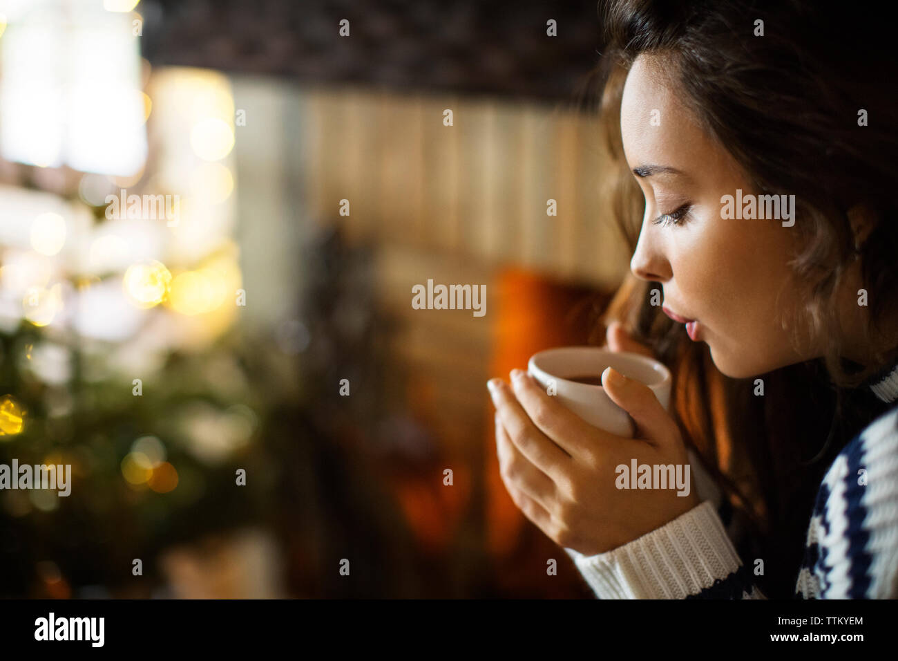 Woman drinking hot coffee at home Stock Photo - Alamy