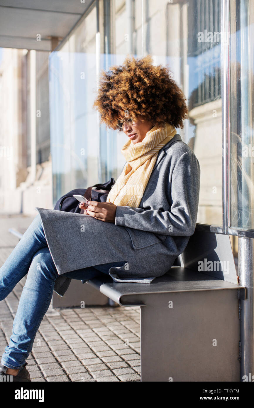 Mobile phone bus stop woman hi-res stock photography and images - Alamy