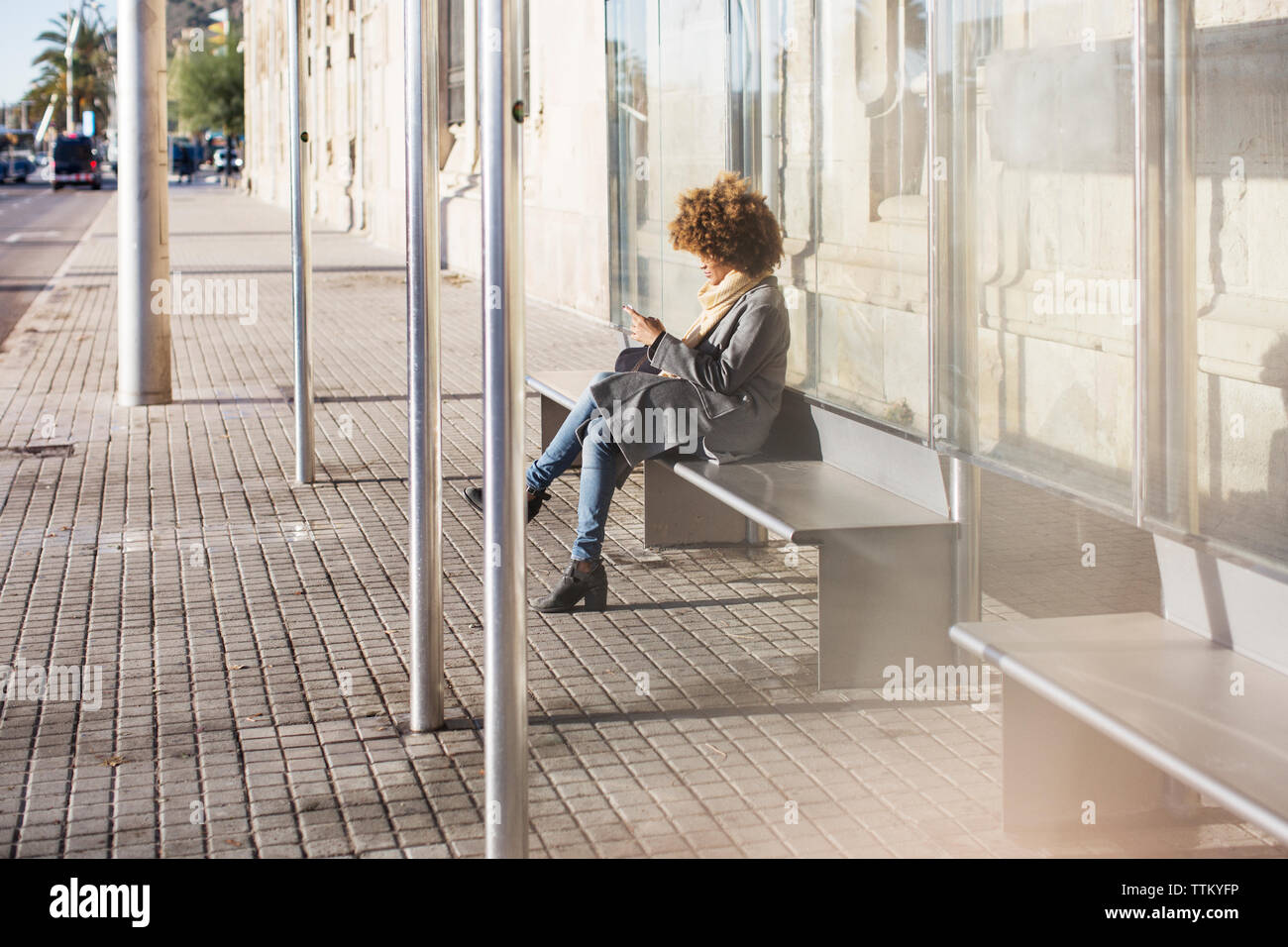 Mobile phone bus stop woman hi-res stock photography and images - Alamy