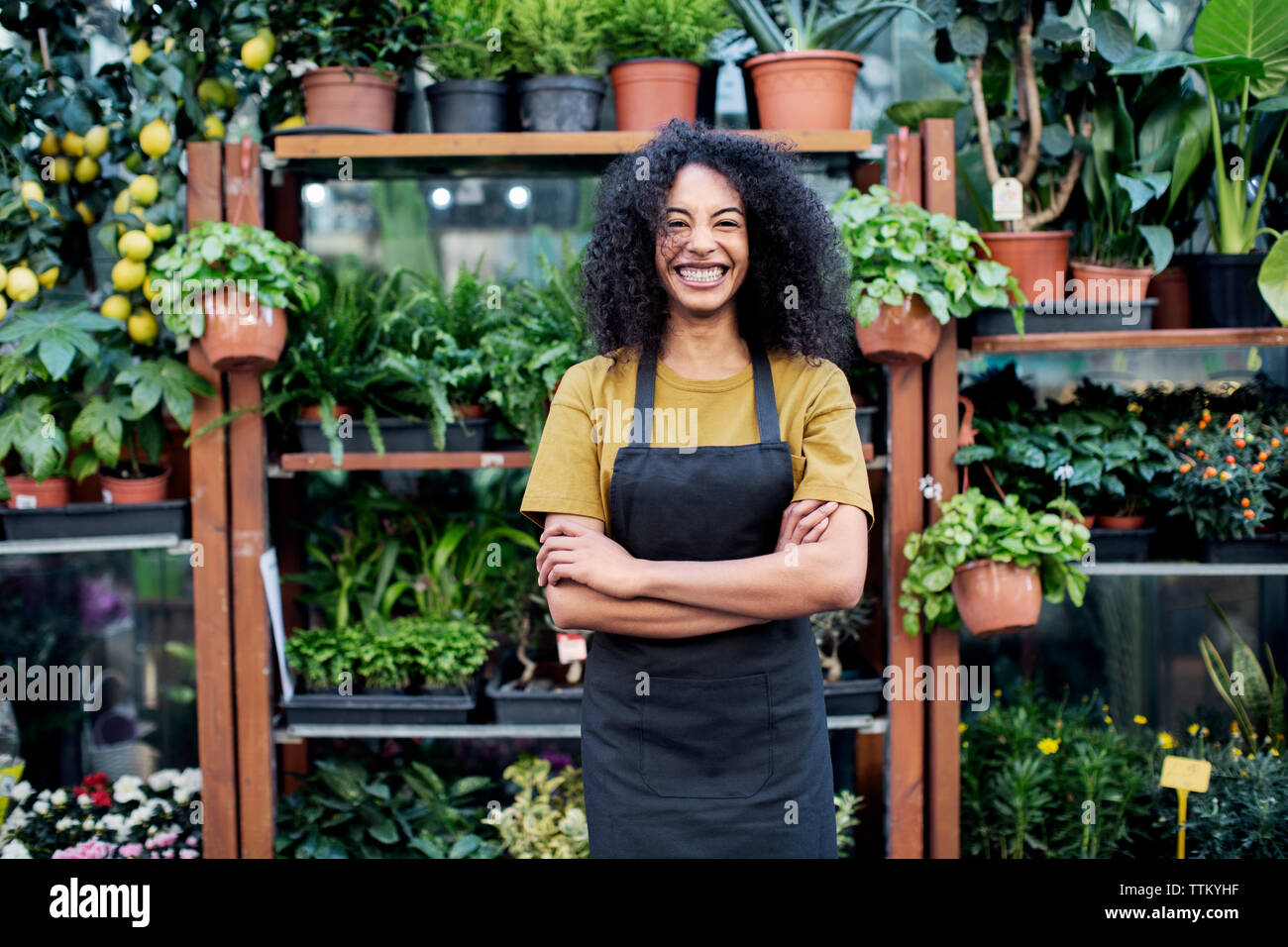 Portrait of cheerful owner standing at market stall Stock Photo - Alamy