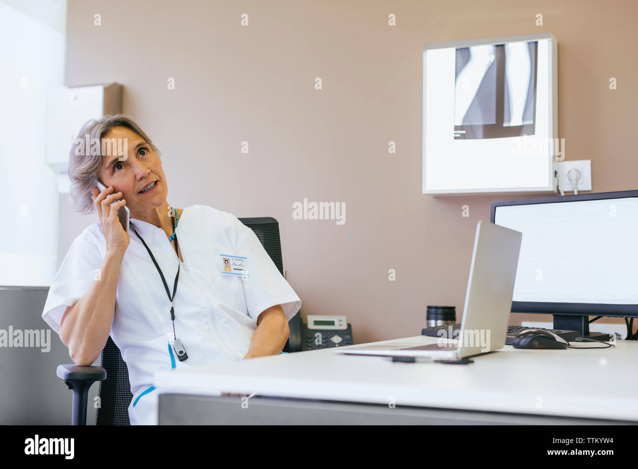 Doctor sitting computer typing text hi-res stock photography and images ...