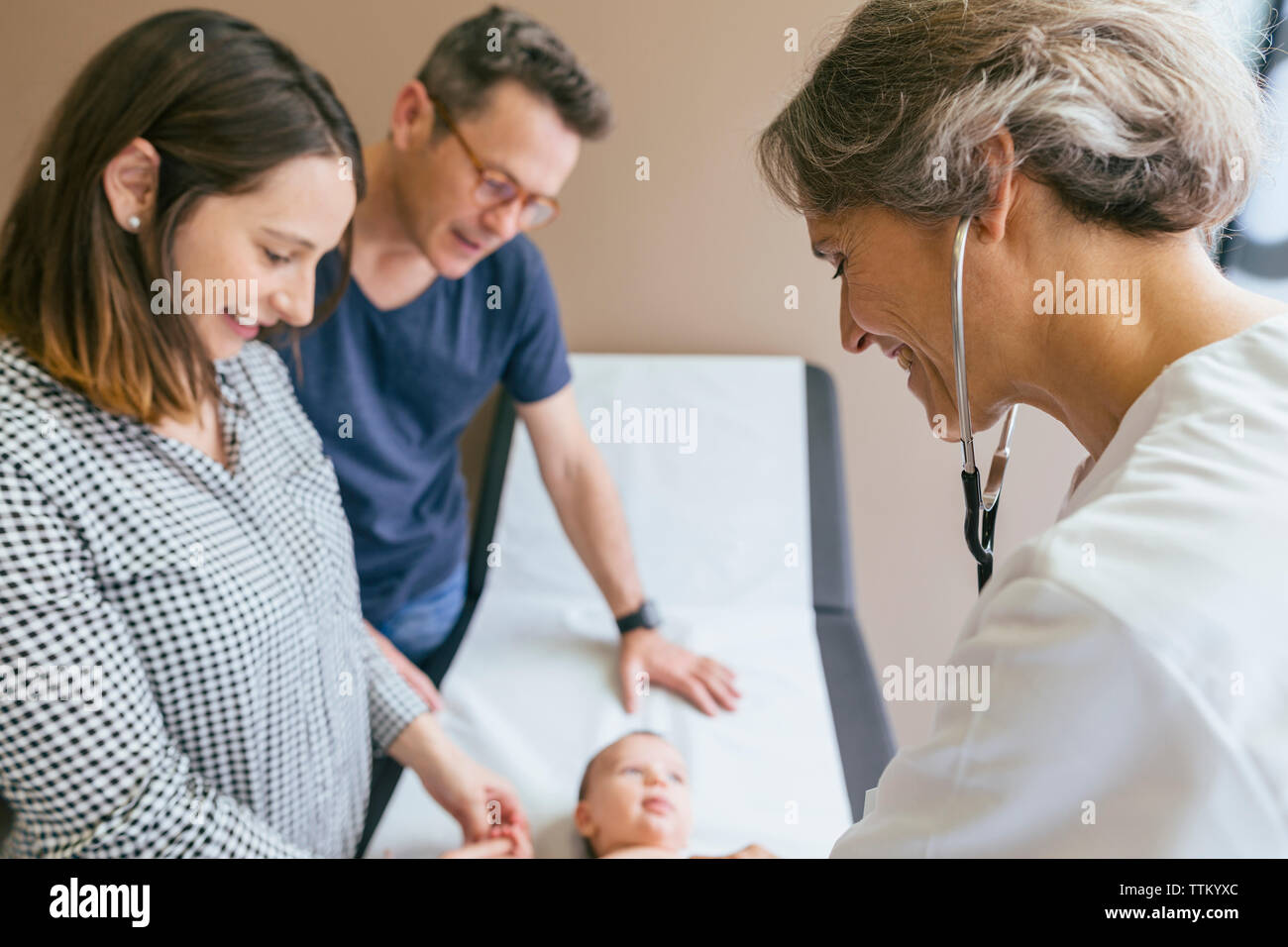 Female doctor examining boy mother hi-res stock photography and images ...